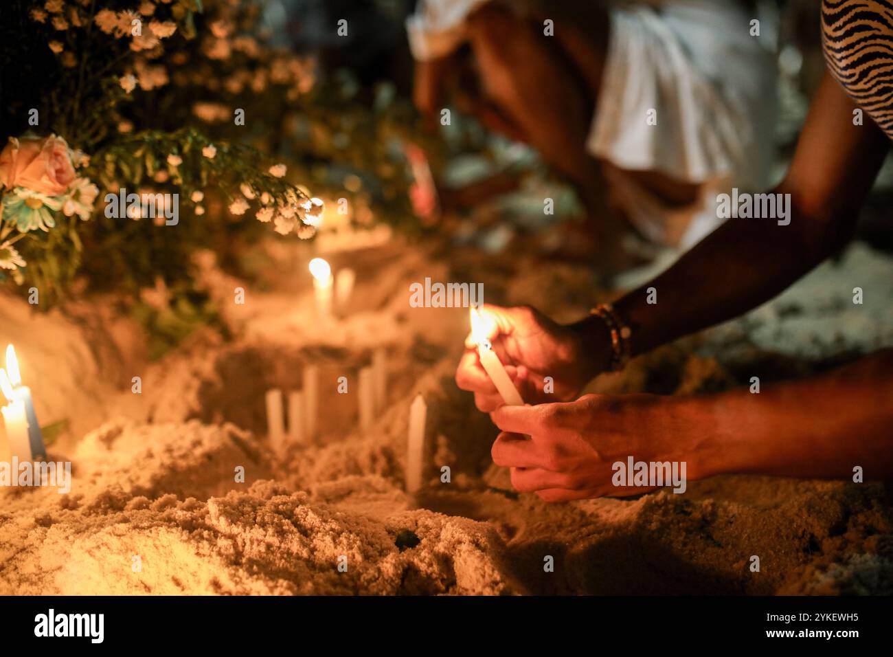 Rio De Janeiro, Brazil. 3rd Feb, 2024. A believer lights a candle as an ...