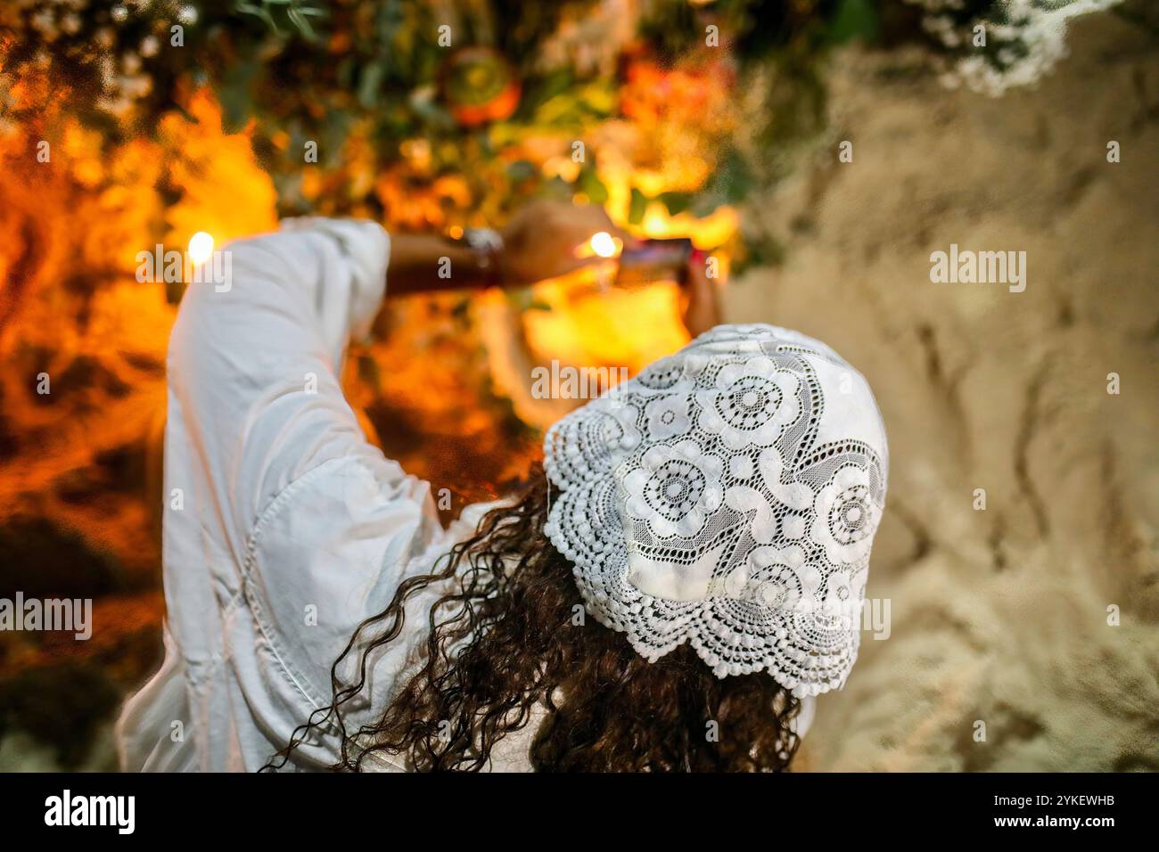 Rio De Janeiro, Brazil. 3rd Feb, 2024. A believer lights a candle as an ...