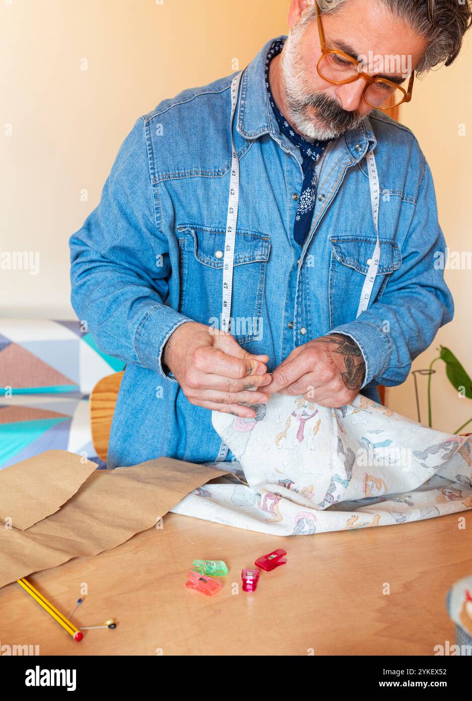 Adult man designing a piece of clothing at home for sewing Stock Photo ...