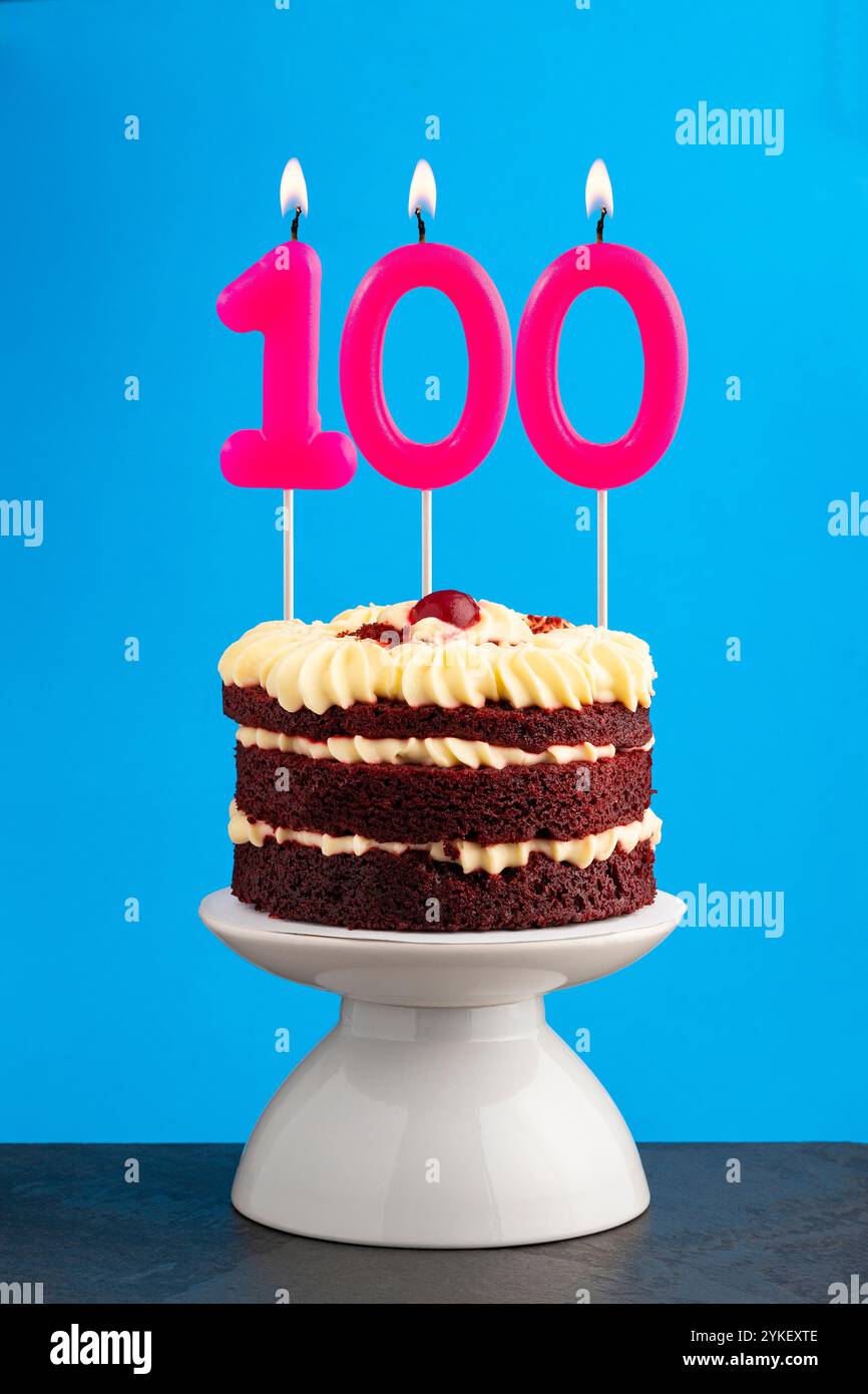 Red velvet birthday cake with number 100 candle Stock Photo - Alamy