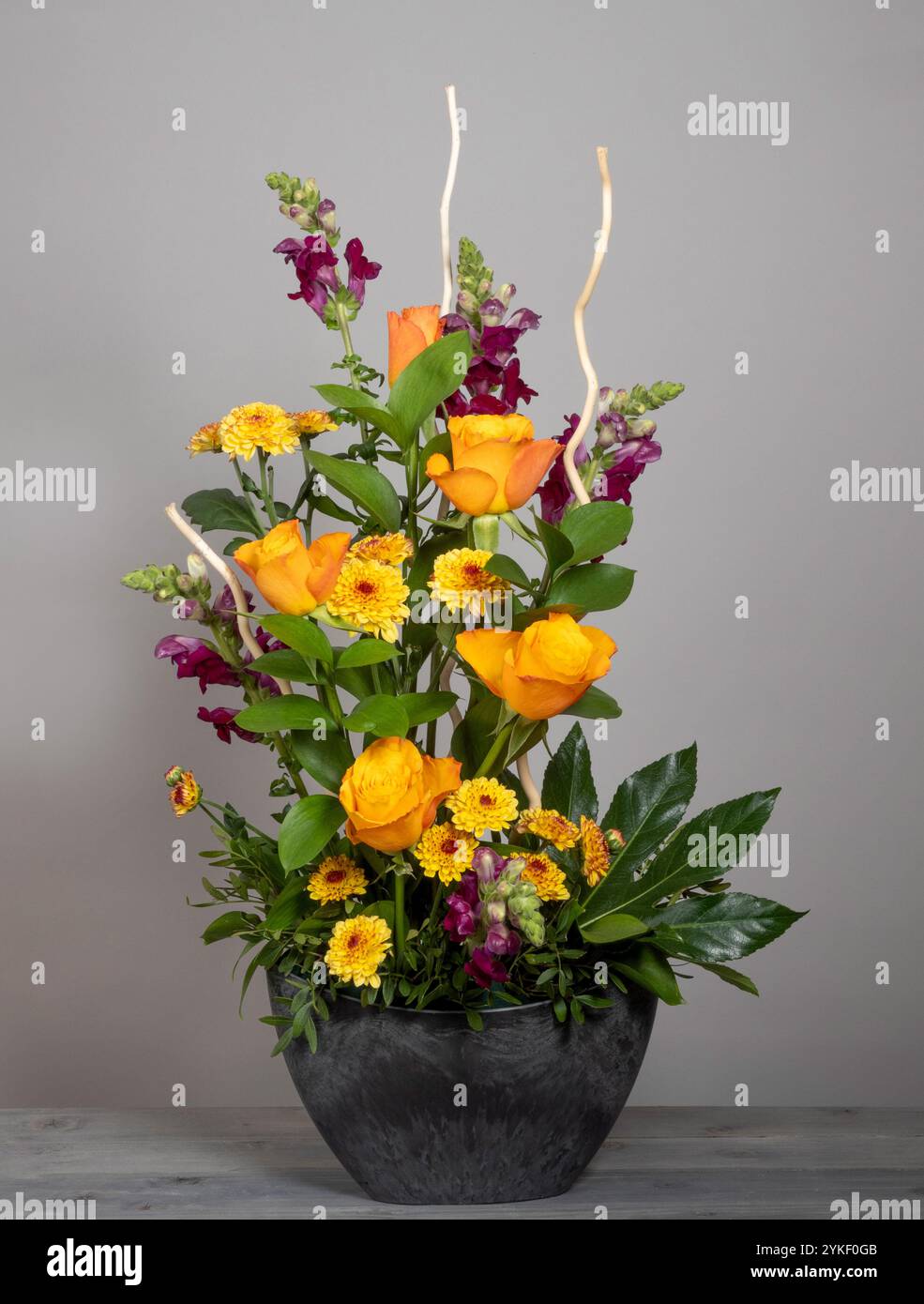 Flower arrangement of orange roses, yellow spray-chrysanthemums and ...