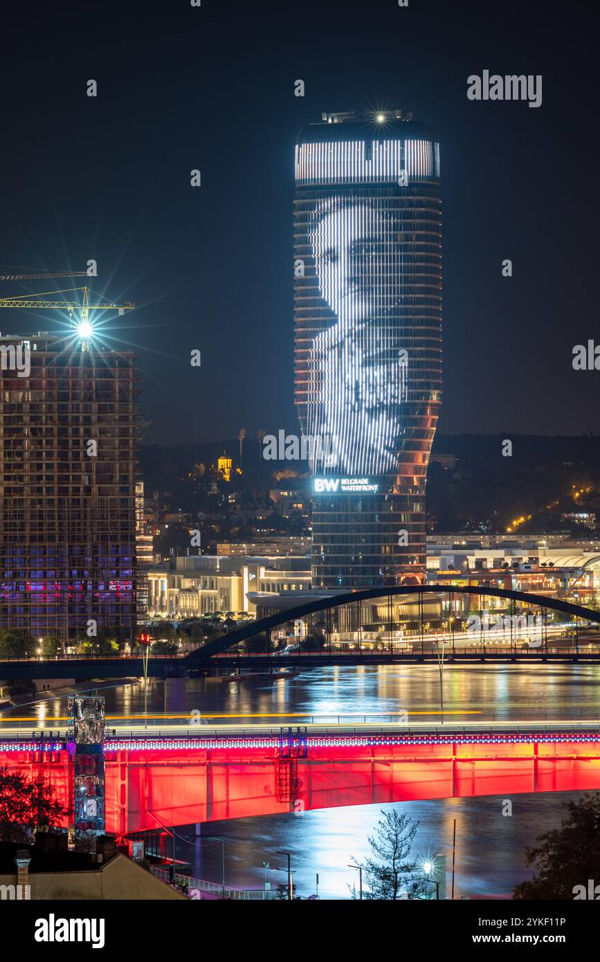 Night view of Belgrade tower skyscraper decorated with image of Serbian ...