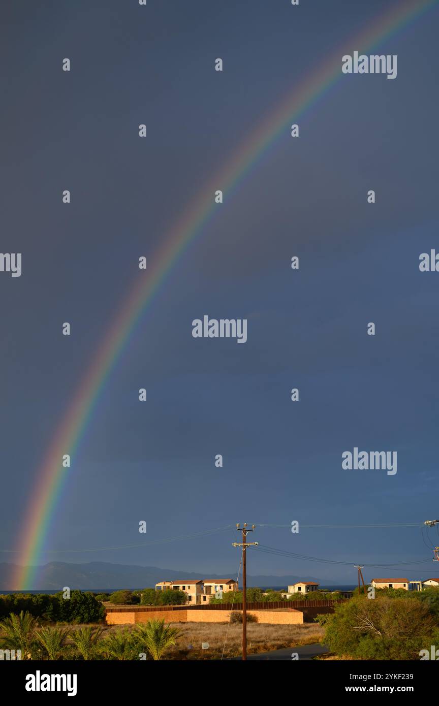 A stunning rainbow stretches across the sky, brightening the calm ...