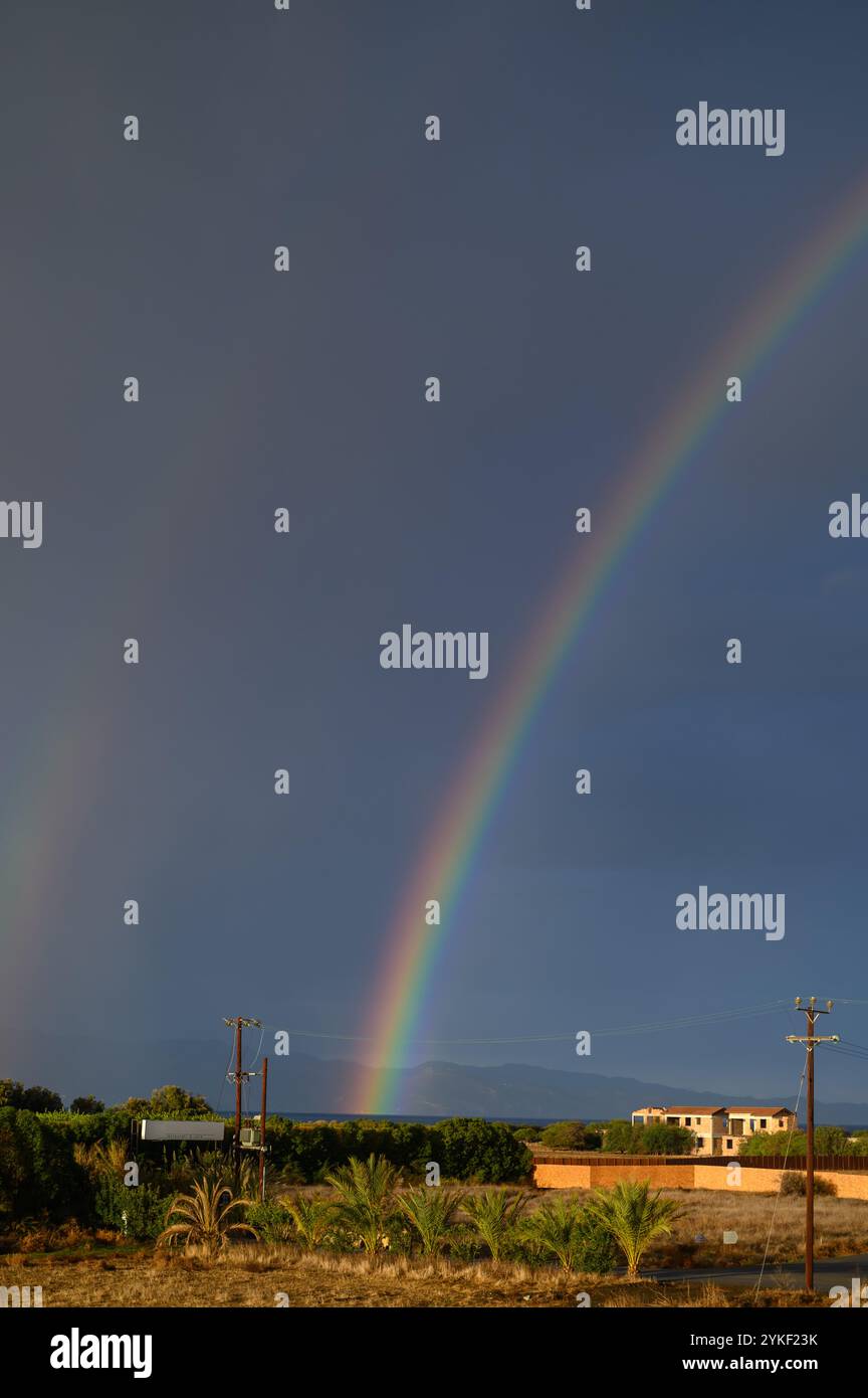 After a refreshing rain, a stunning rainbow stretches across the sky ...