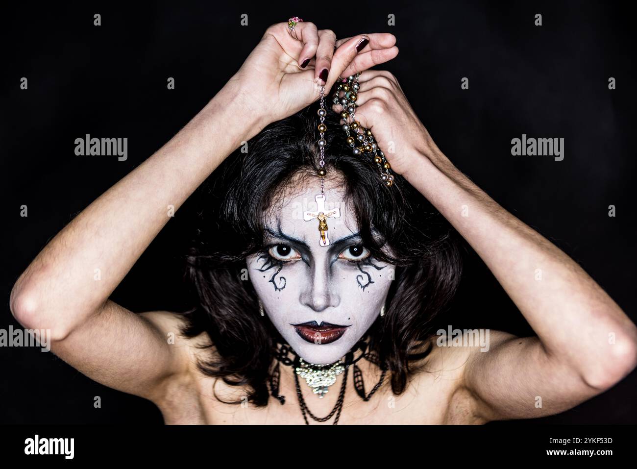 A woman embraces a gothic aesthetic, showcasing dramatic makeup with ...