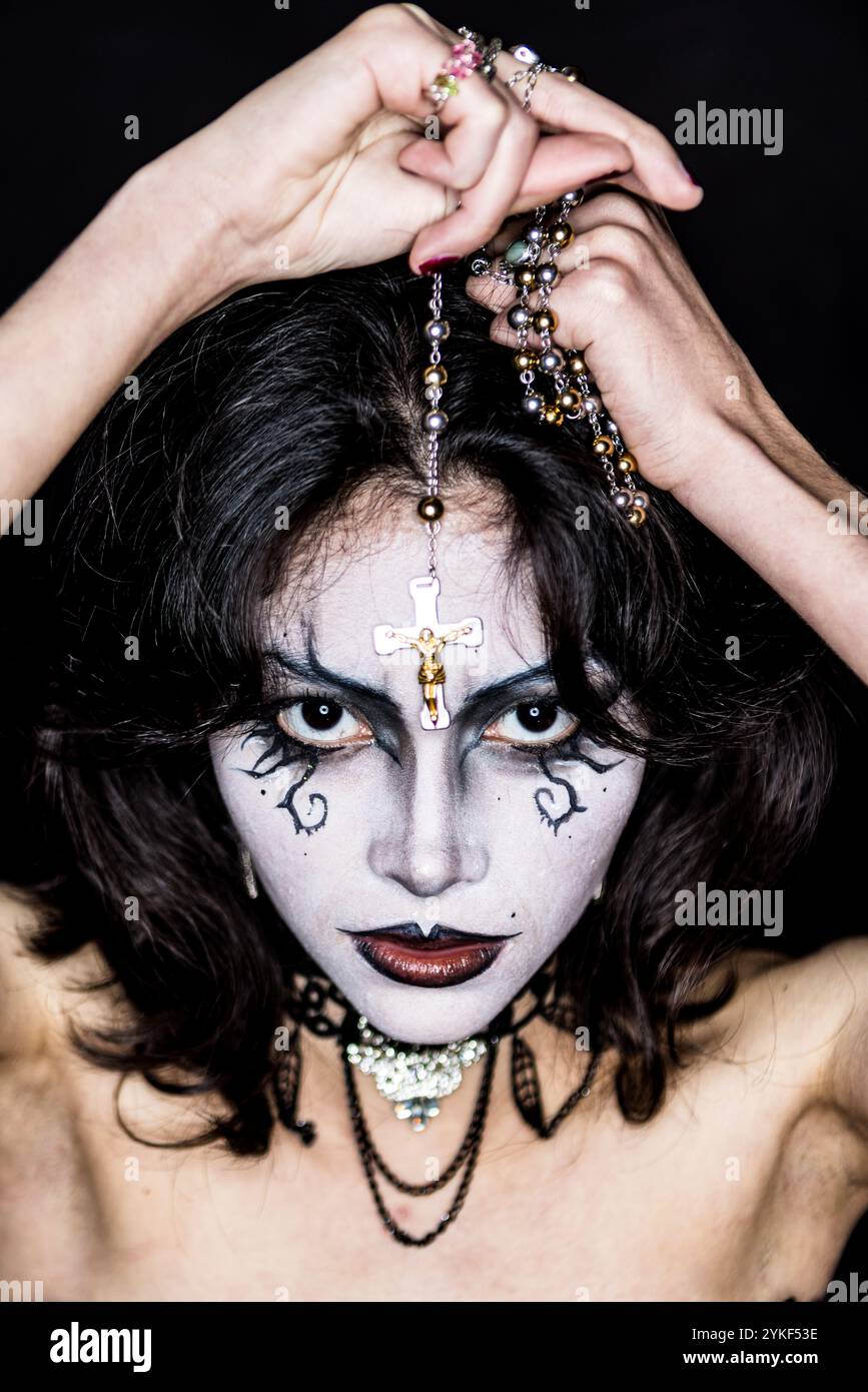 A striking image of a woman in gothic makeup, featuring bold black and ...