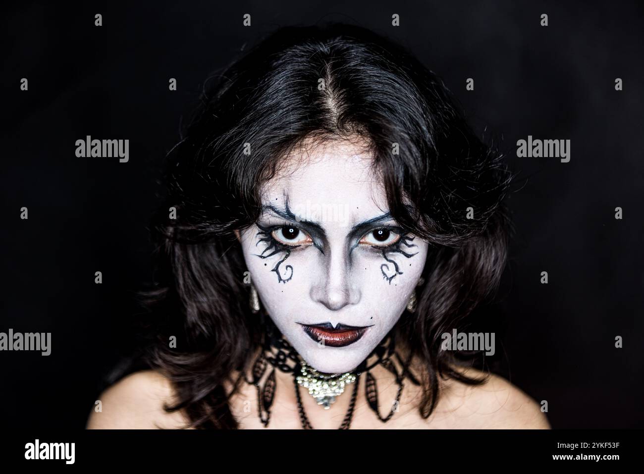 A striking portrait of a woman with intense, dramatic gothic makeup Her ...