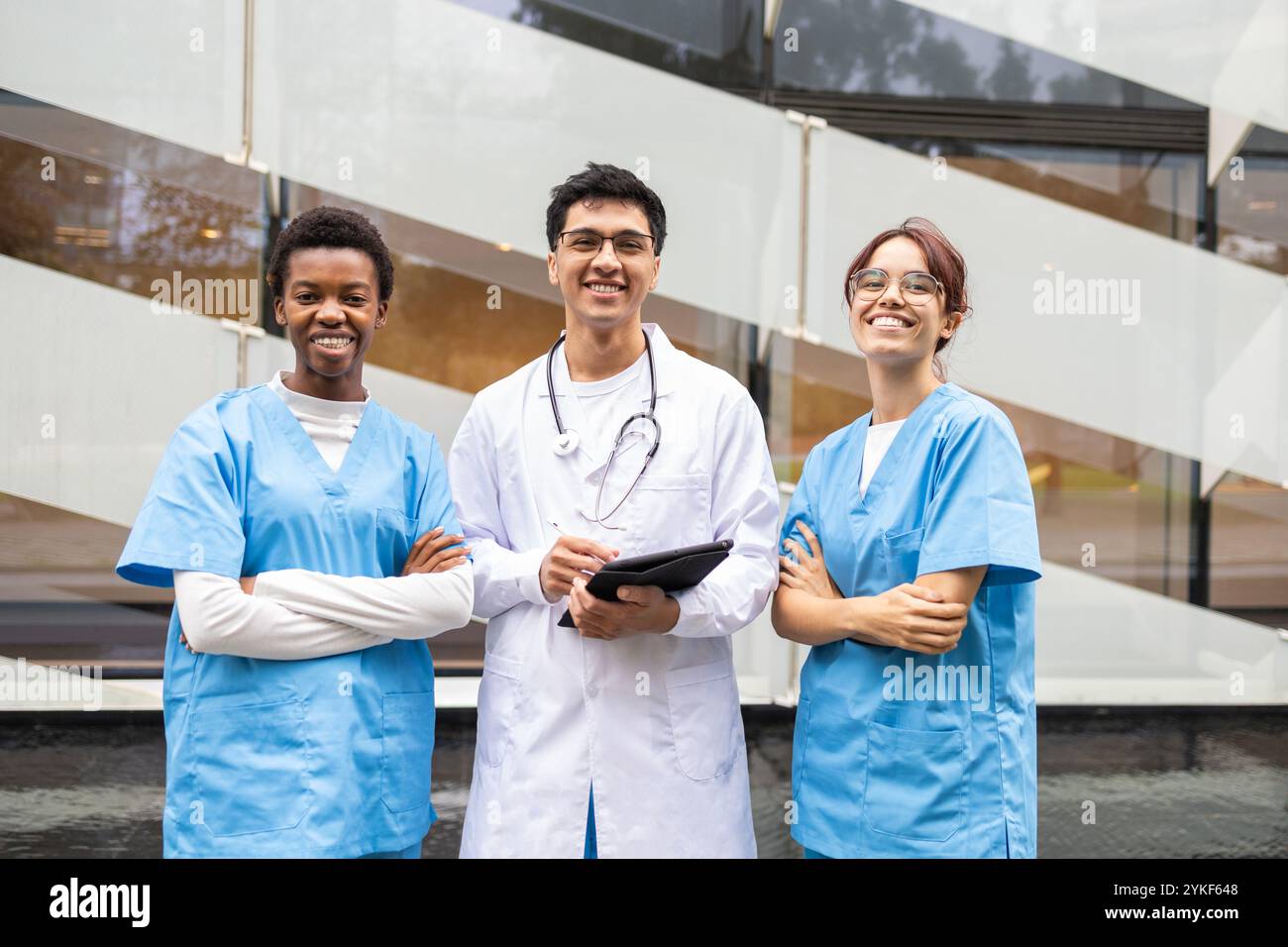 Three cheerful nursing students, representing different ethnic ...