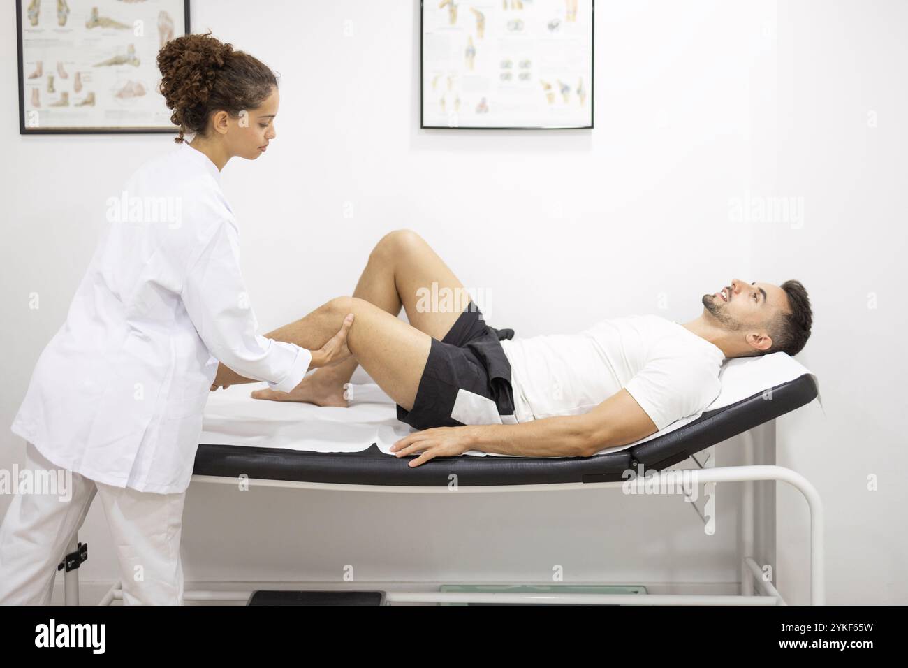 A healthcare professional conducts an orthopedic leg assessment on a ...