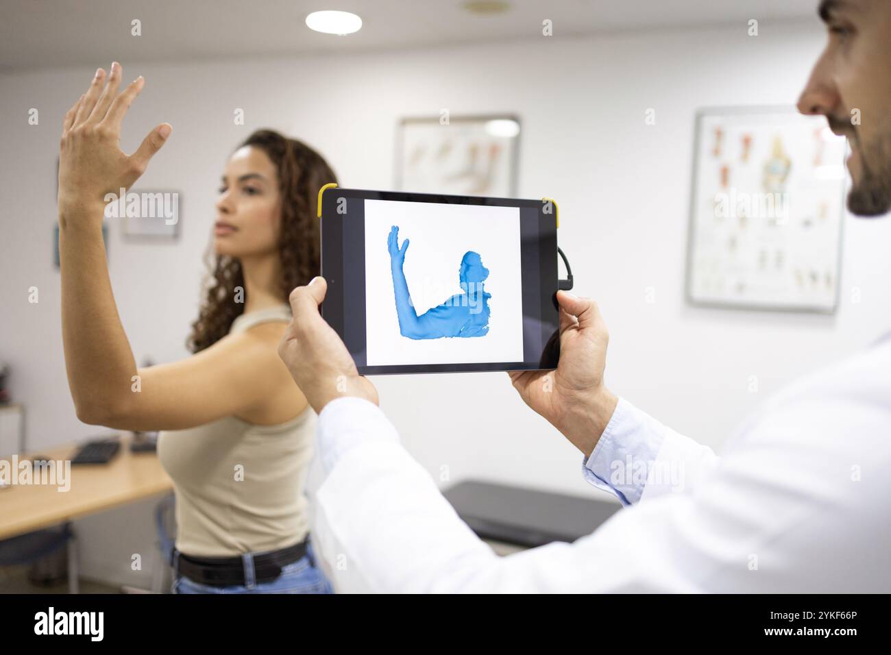 A medical professional uses a tablet with 3D imaging technology to ...