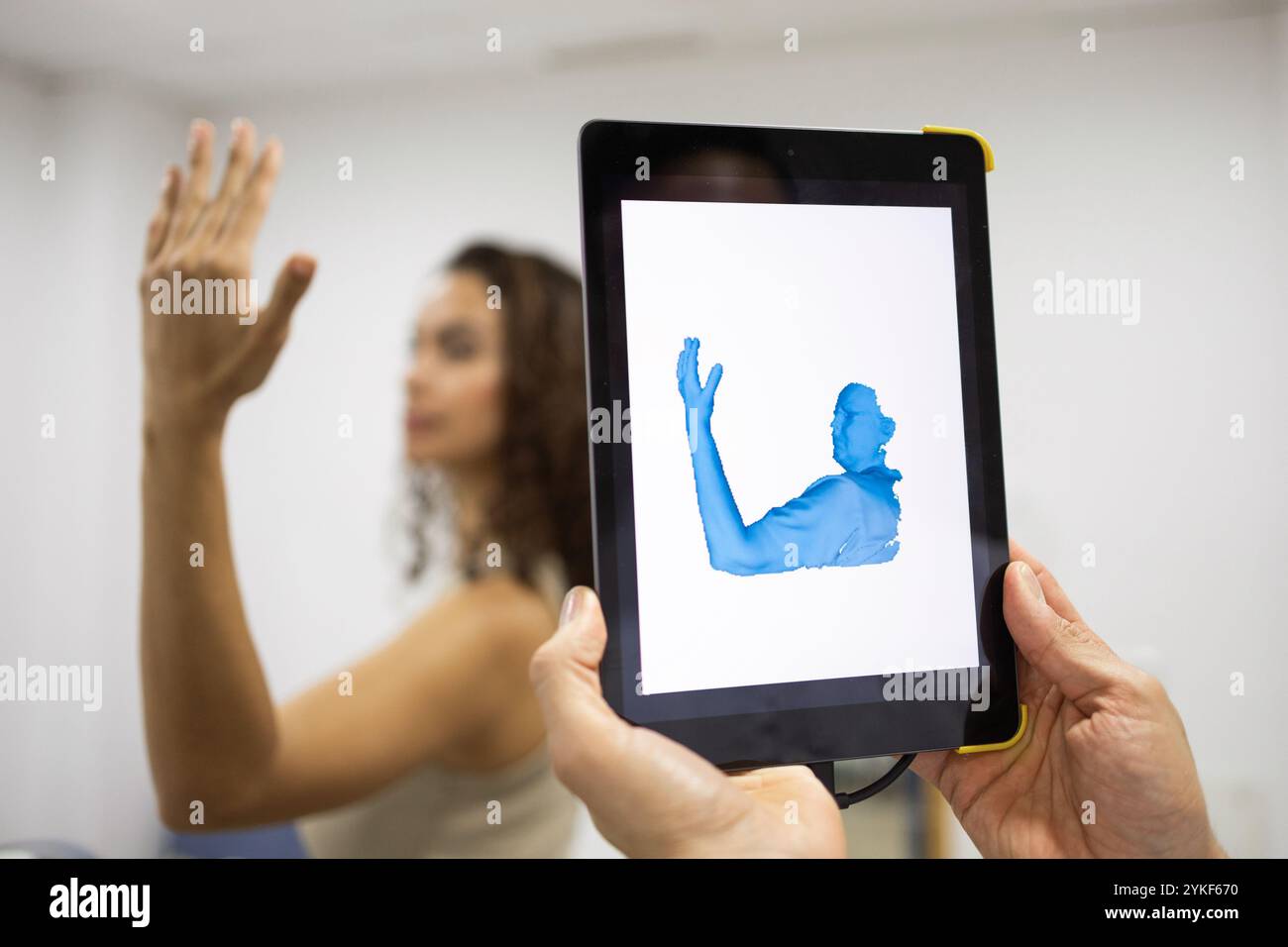 A professional demonstrates advanced 3D scanning technology in an ...