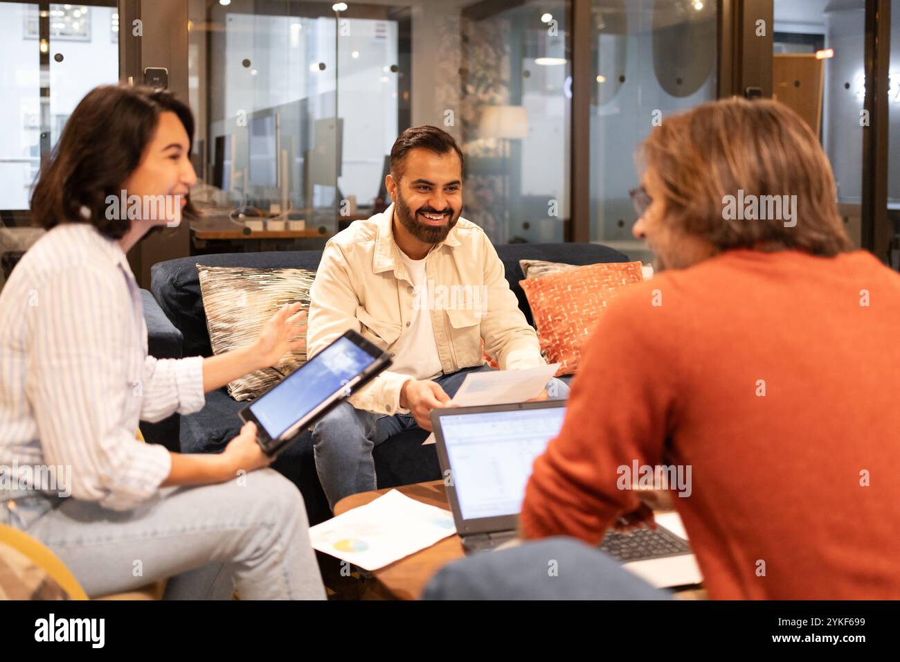 A group of professionals engaged in a lively discussion in a cozy ...
