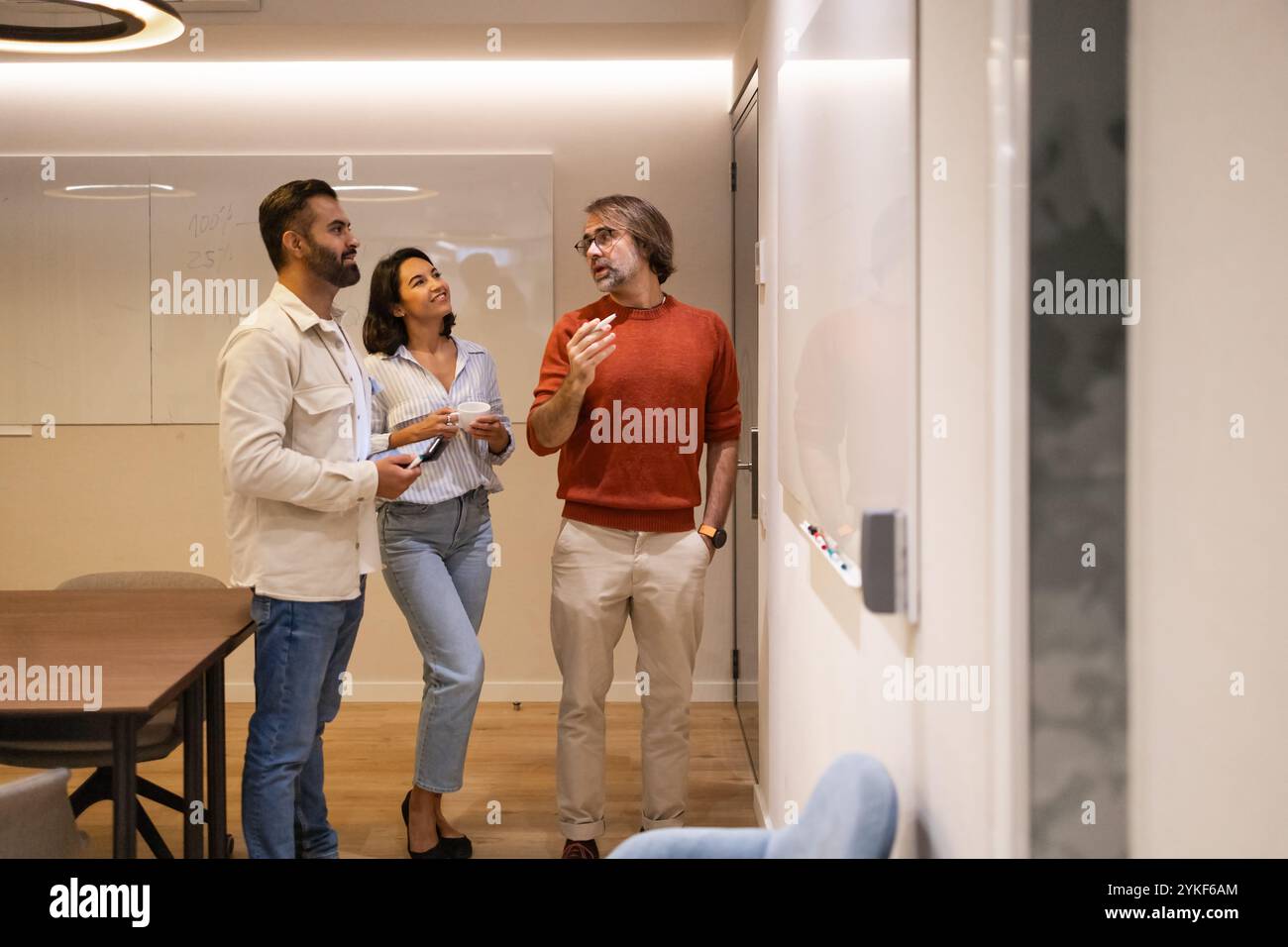 A diverse group of professionals engage in a collaborative discussion ...