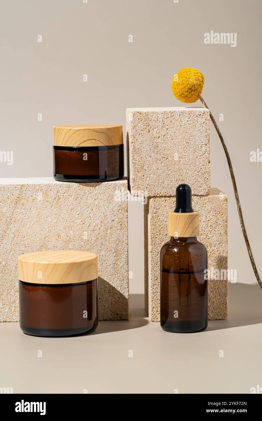 Eco-friendly cosmetic containers artfully arranged on textured stone ...