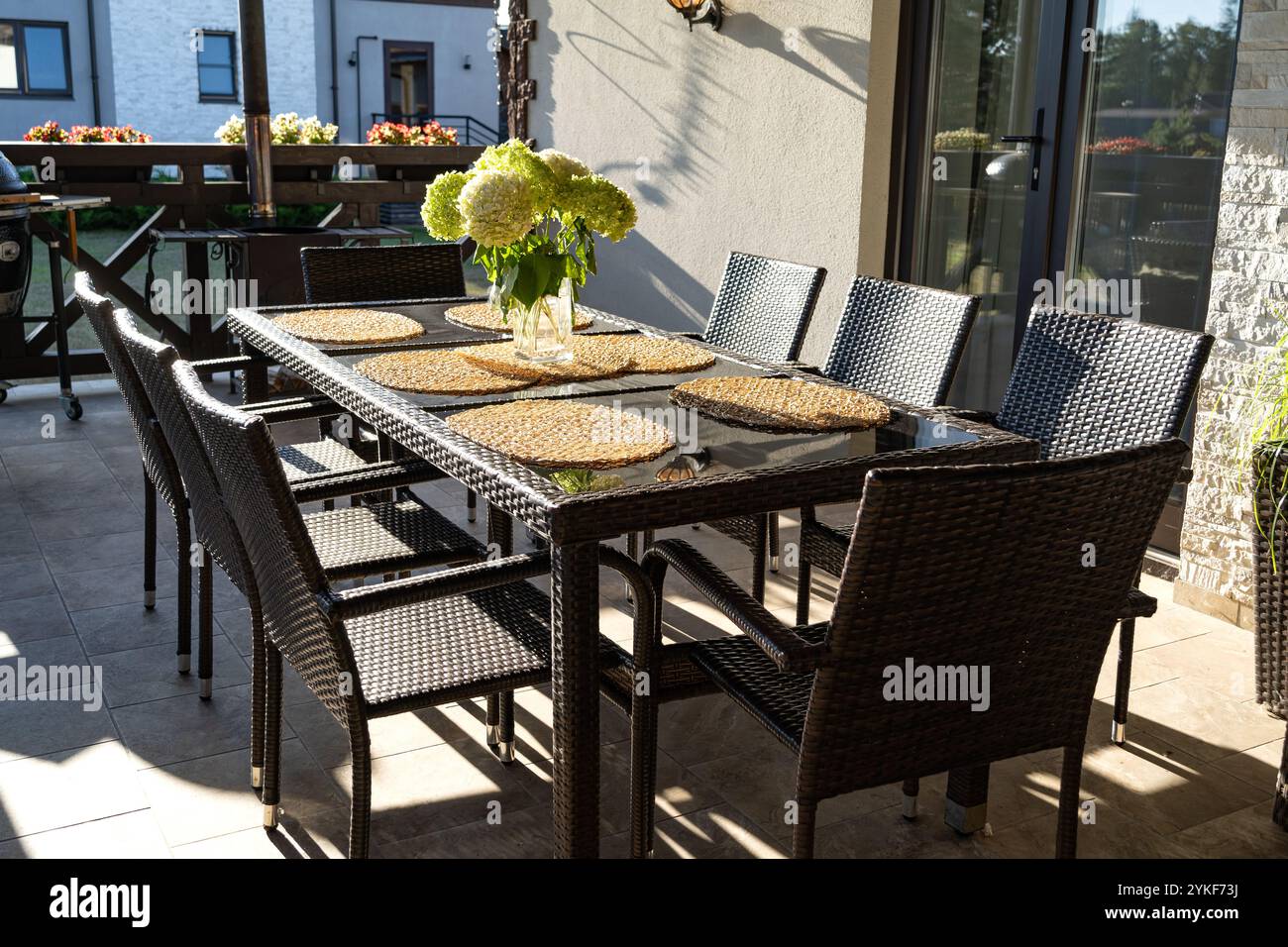 An inviting outdoor dining space on a sunlit terrace, featuring a ...