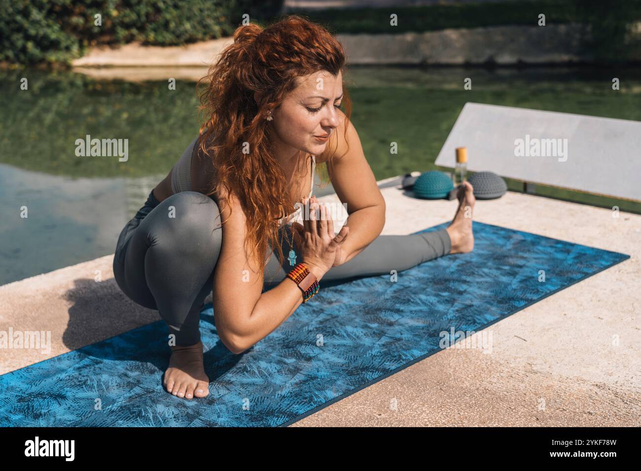 Woman yoga instructor demonstrates Ardha Malasana, or Half Squat Pose ...