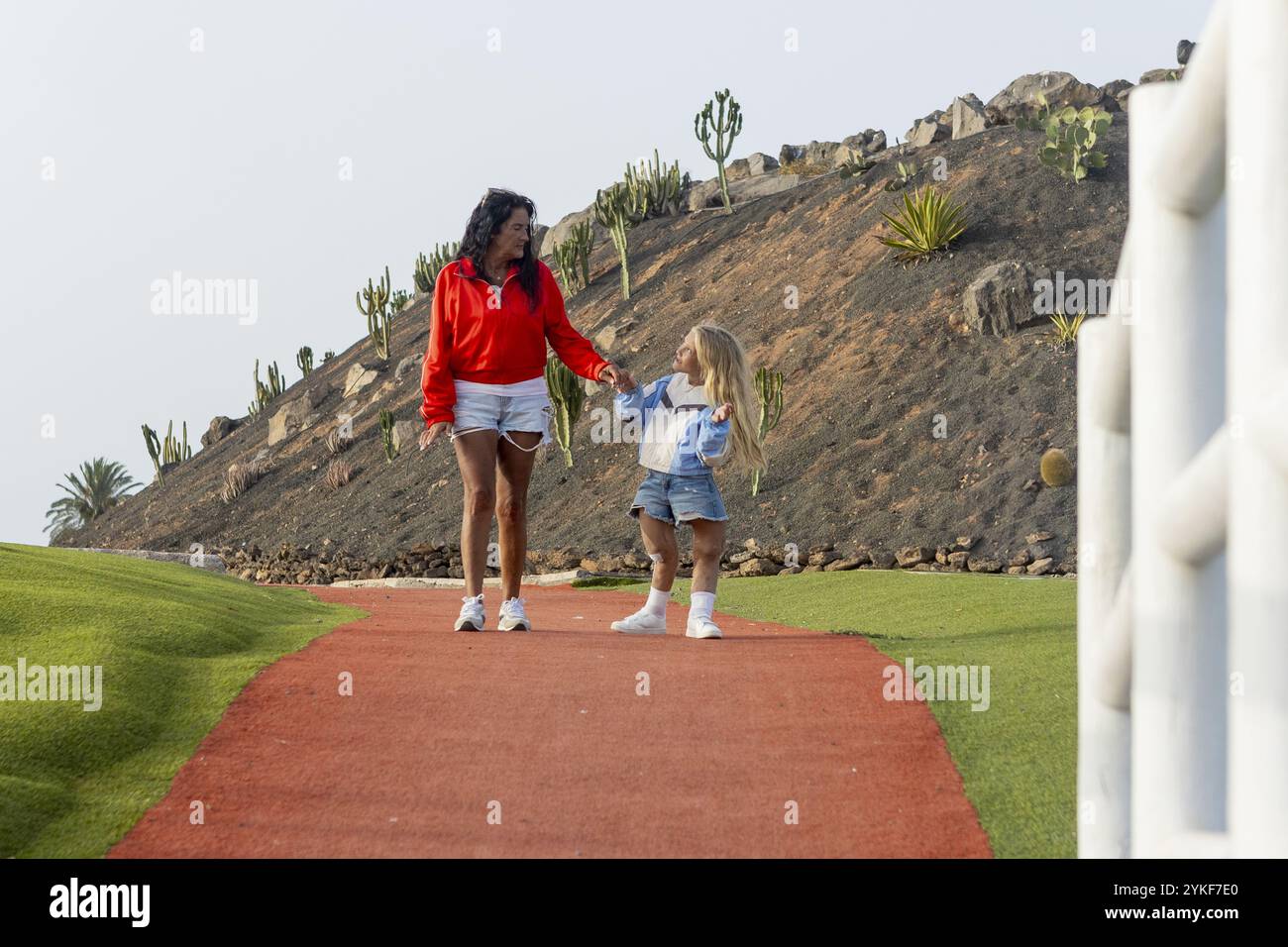 Mother and her daughter with Stuve-Wiedemann syndrome walk hand in hand ...