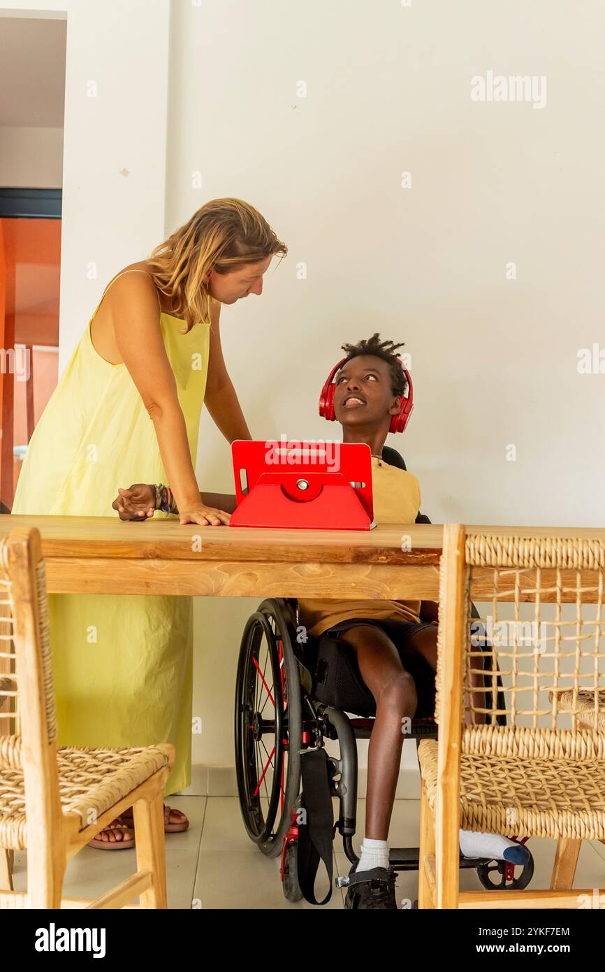 A boy with cerebral palsy engages in an educational session with his ...