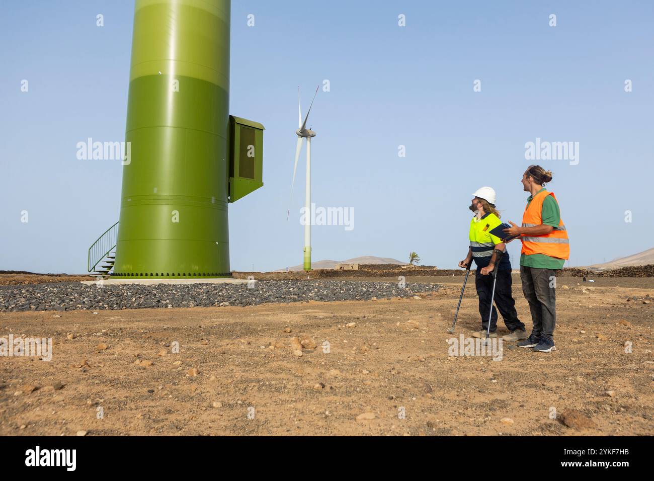 A disabled inspector with a crutch and a colleague evaluate safety at a ...