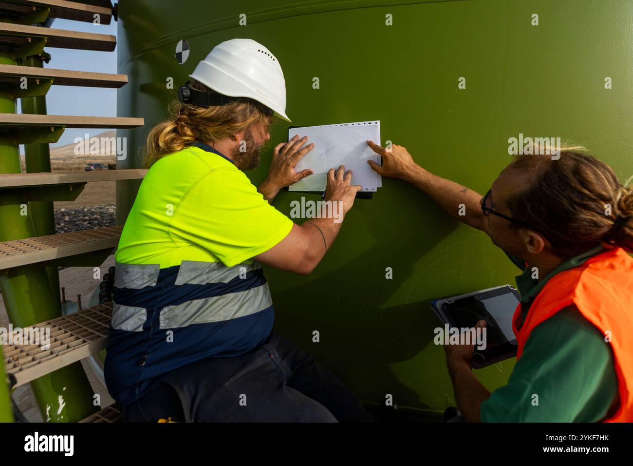 A disabled inspector collaborates with a colleague on a renewable ...