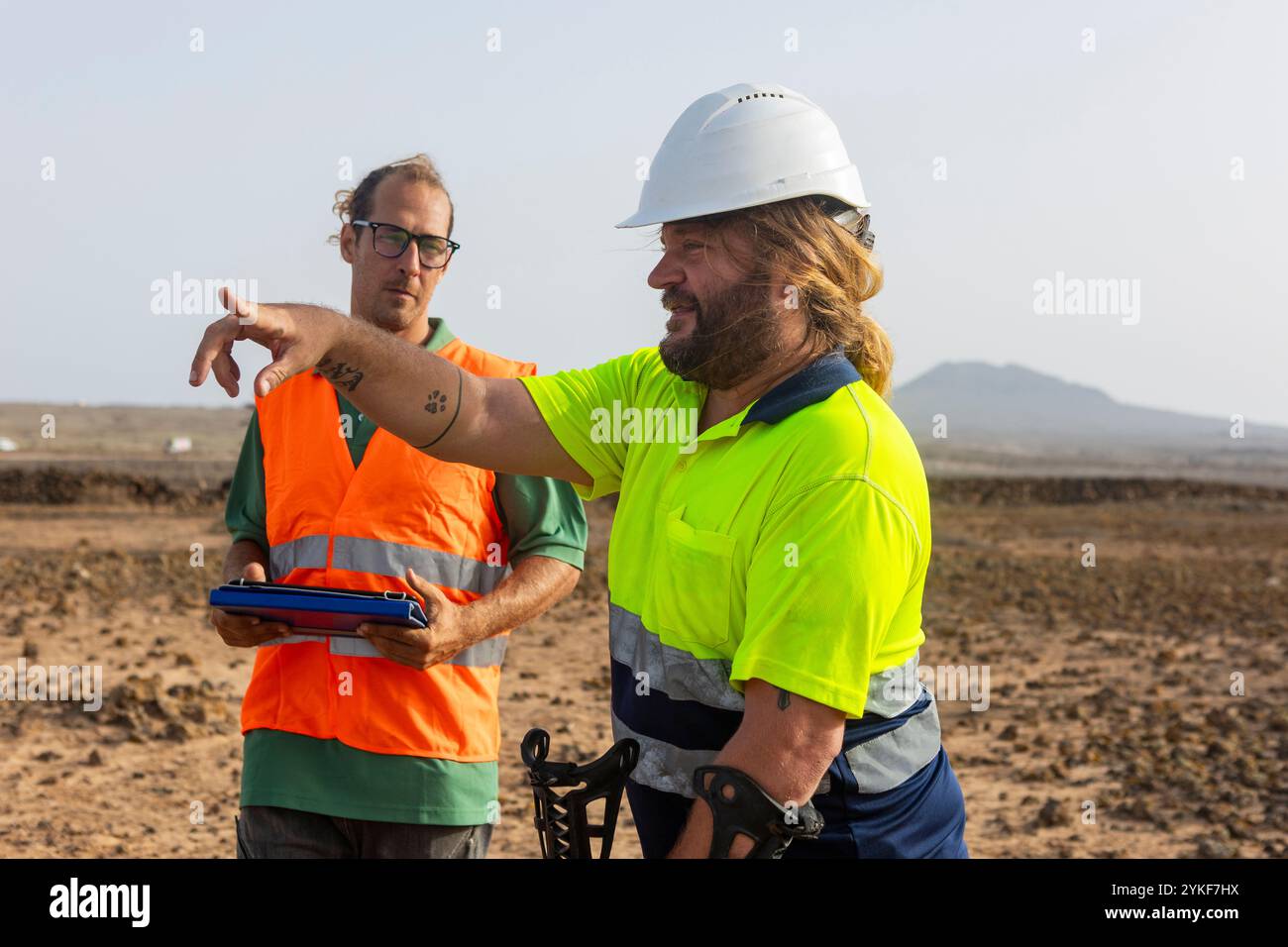 A disabled safety inspector on crutches reviews safety protocols with a ...
