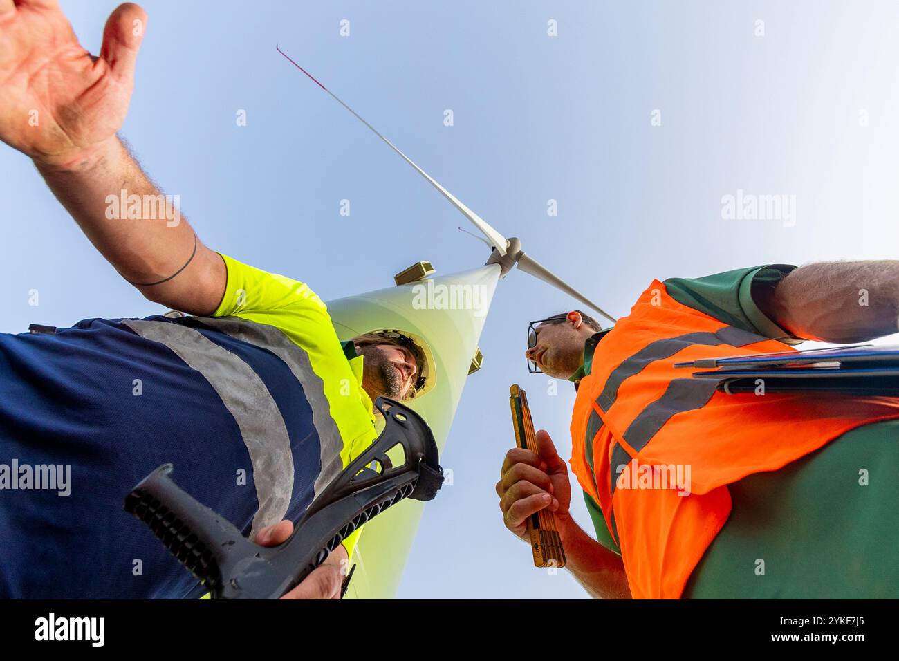 A disabled safety inspector, using crutches, converses with a colleague ...