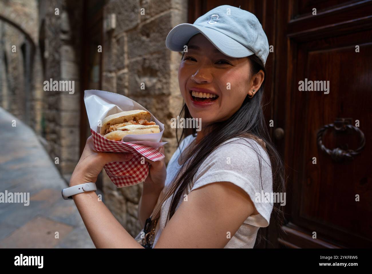 An asian woman savors traditional Italian street food while exploring ...