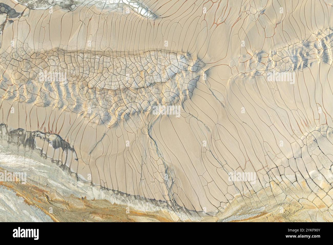 A close-up photograph revealing the intricate patterns of cracked mud ...