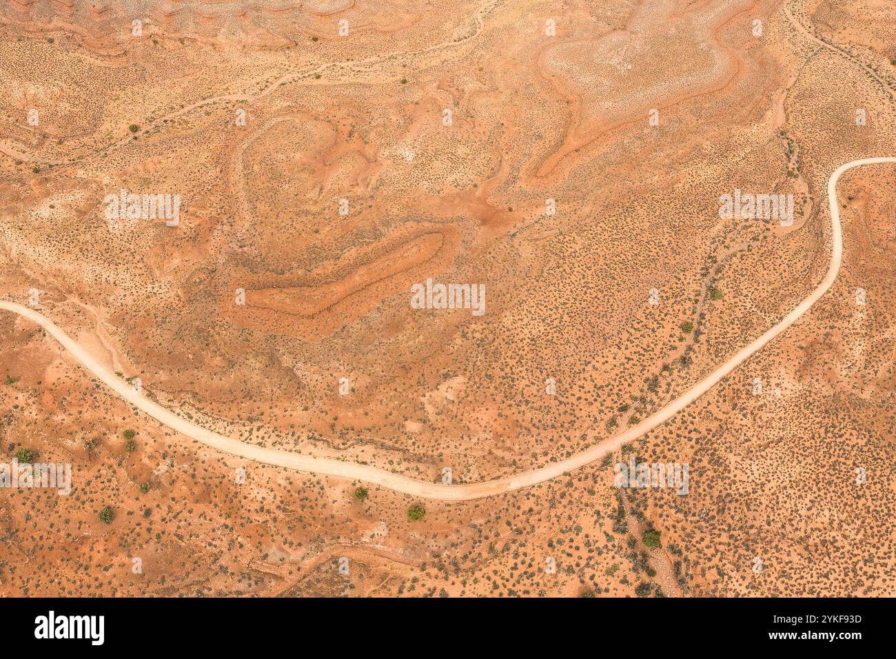 From above, this image captures a serpentine road winding through the ...