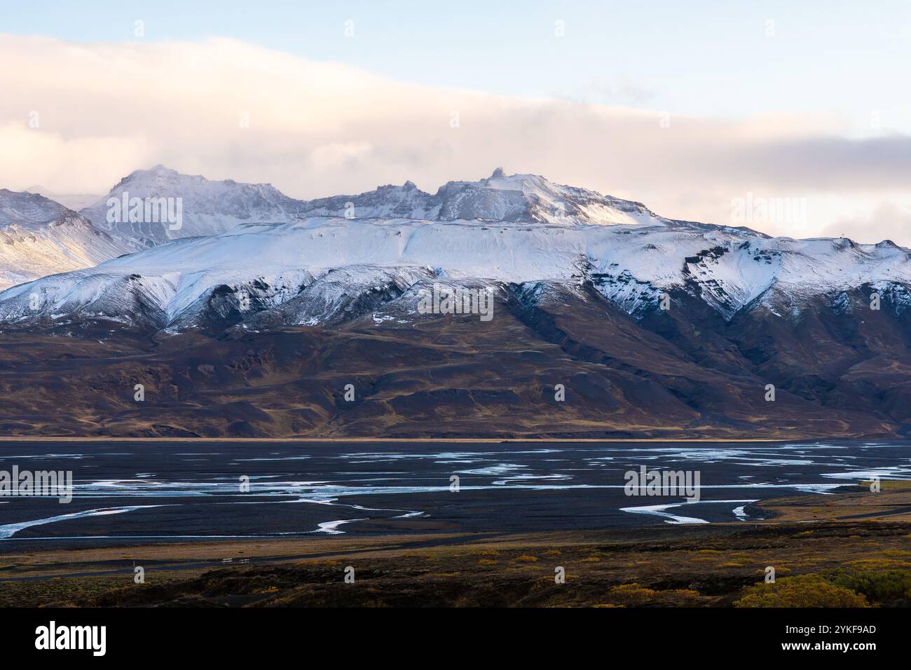 A stunning Icelandic highland view with snow-capped mountains, winding ...