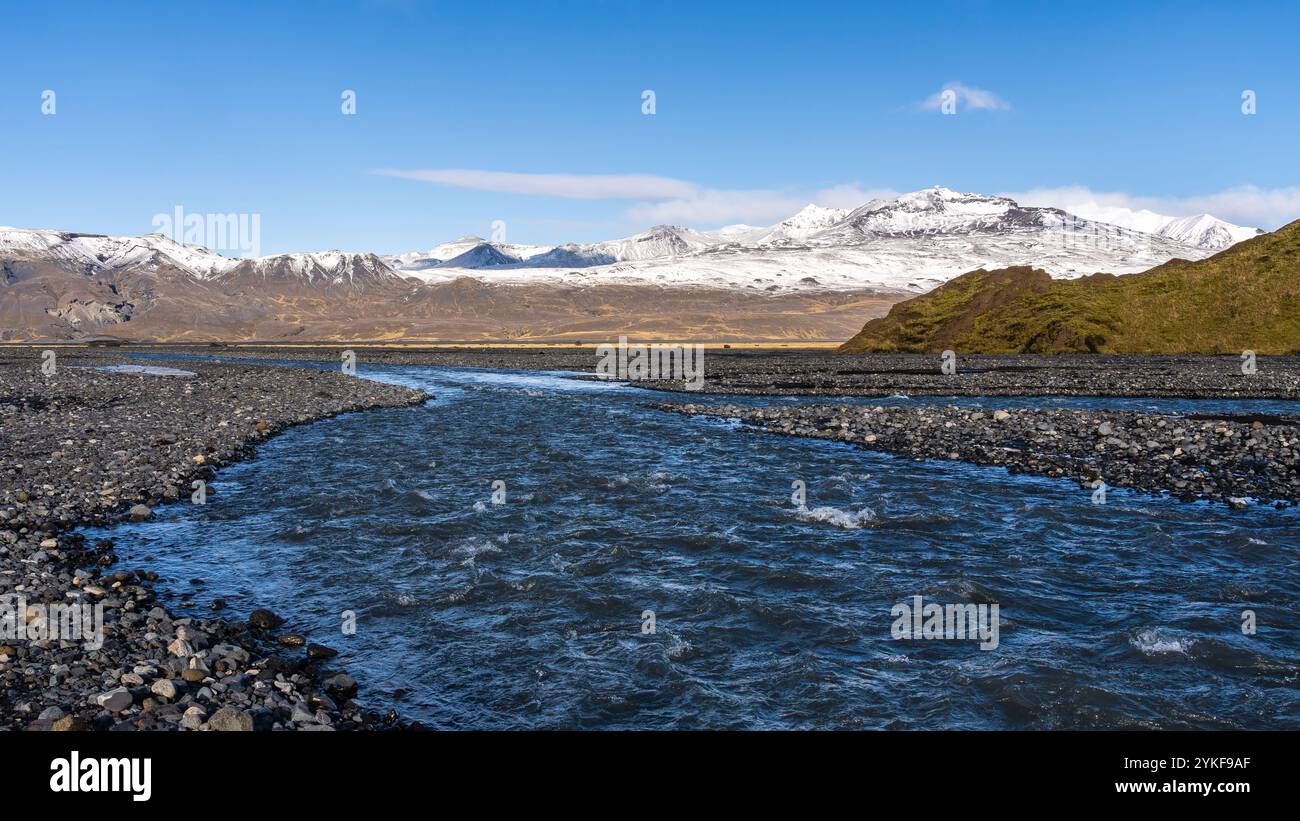 River flows through the rugged Highlands of Iceland, set against a ...