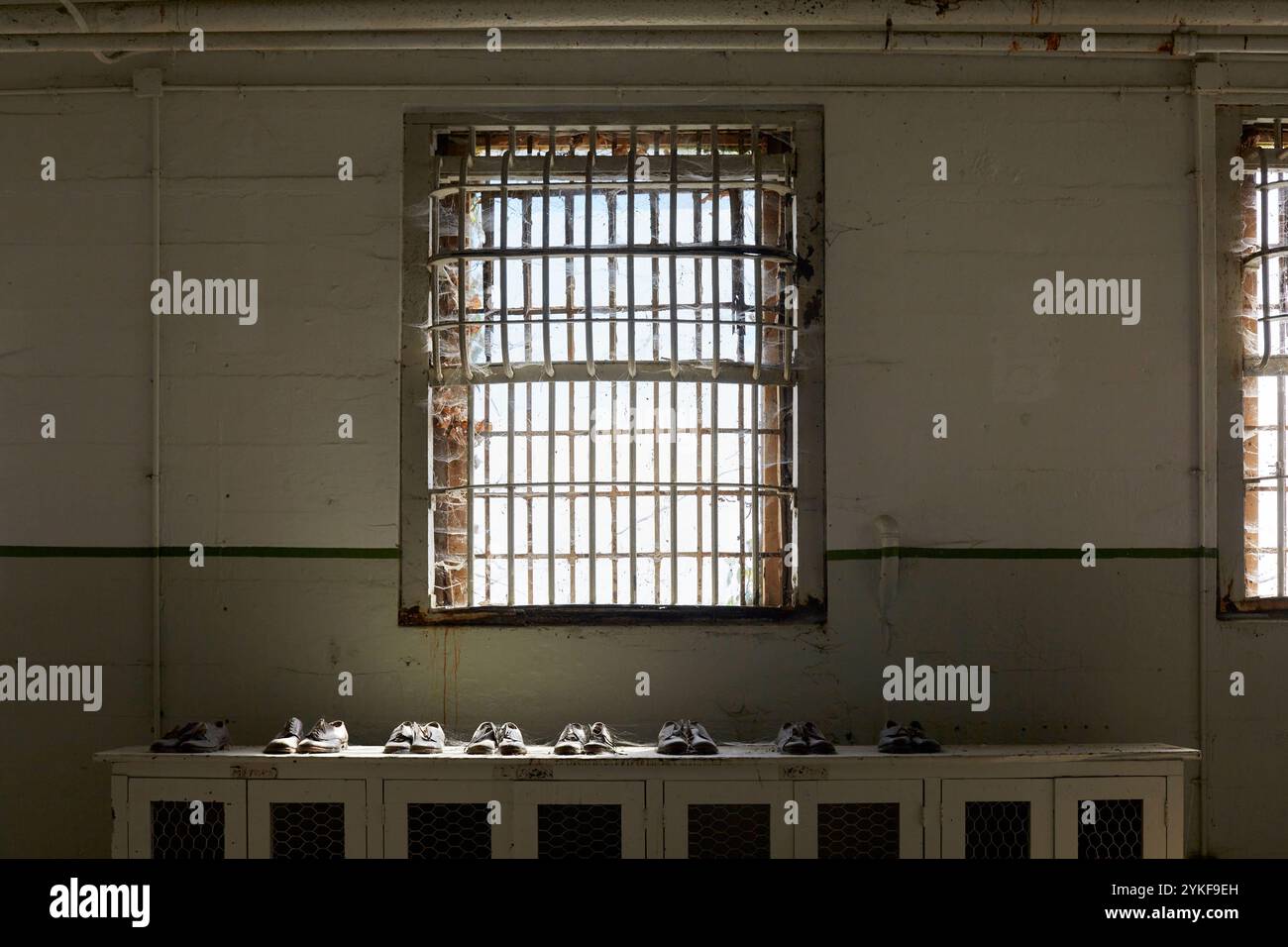 Vintage locker room featuring rows of sneakers lined up beneath a large ...