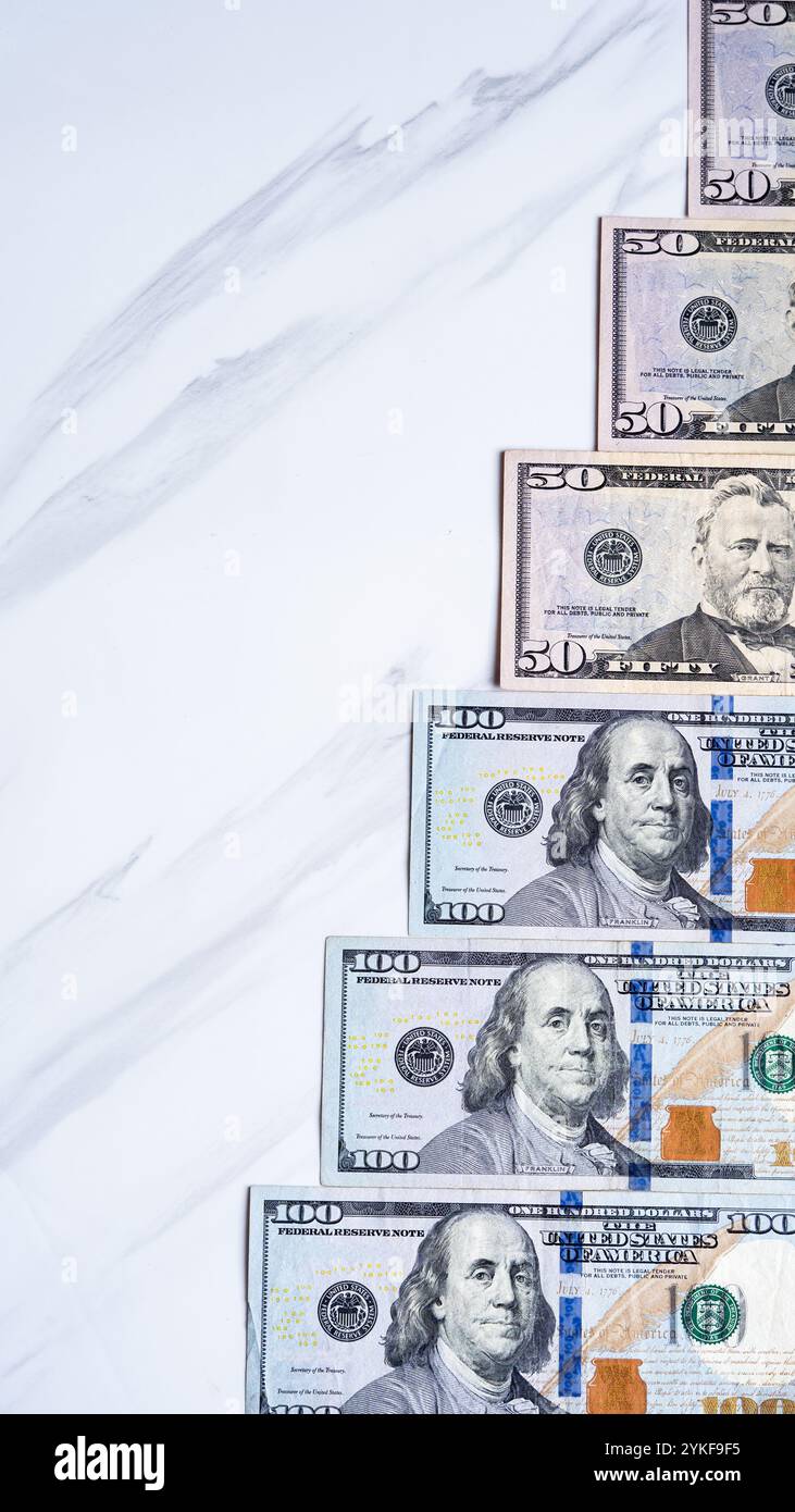 A visually appealing arrangement of US dollar bills, including 50 and ...