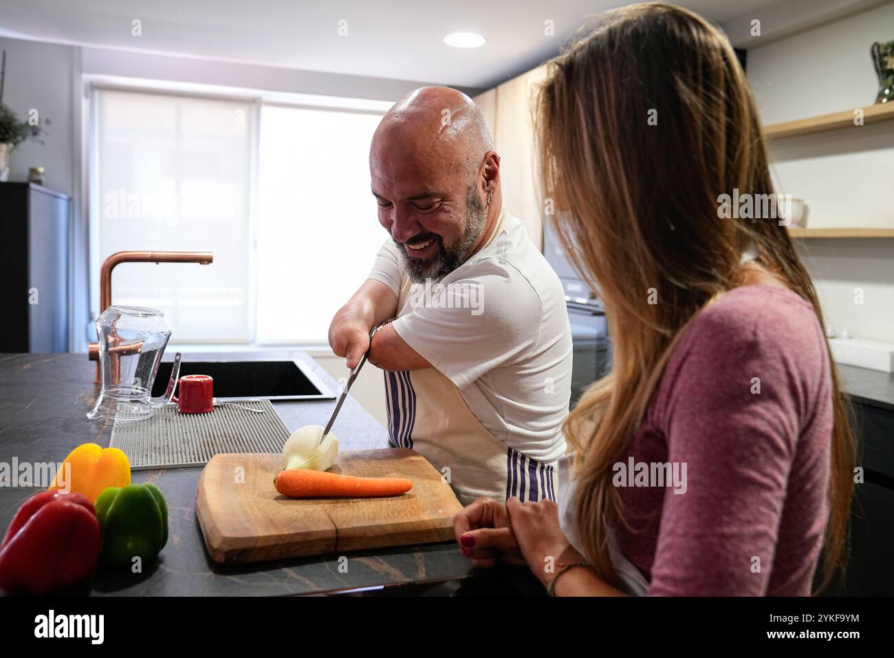 A disability man with a positive attitude confidently chops vegetables ...