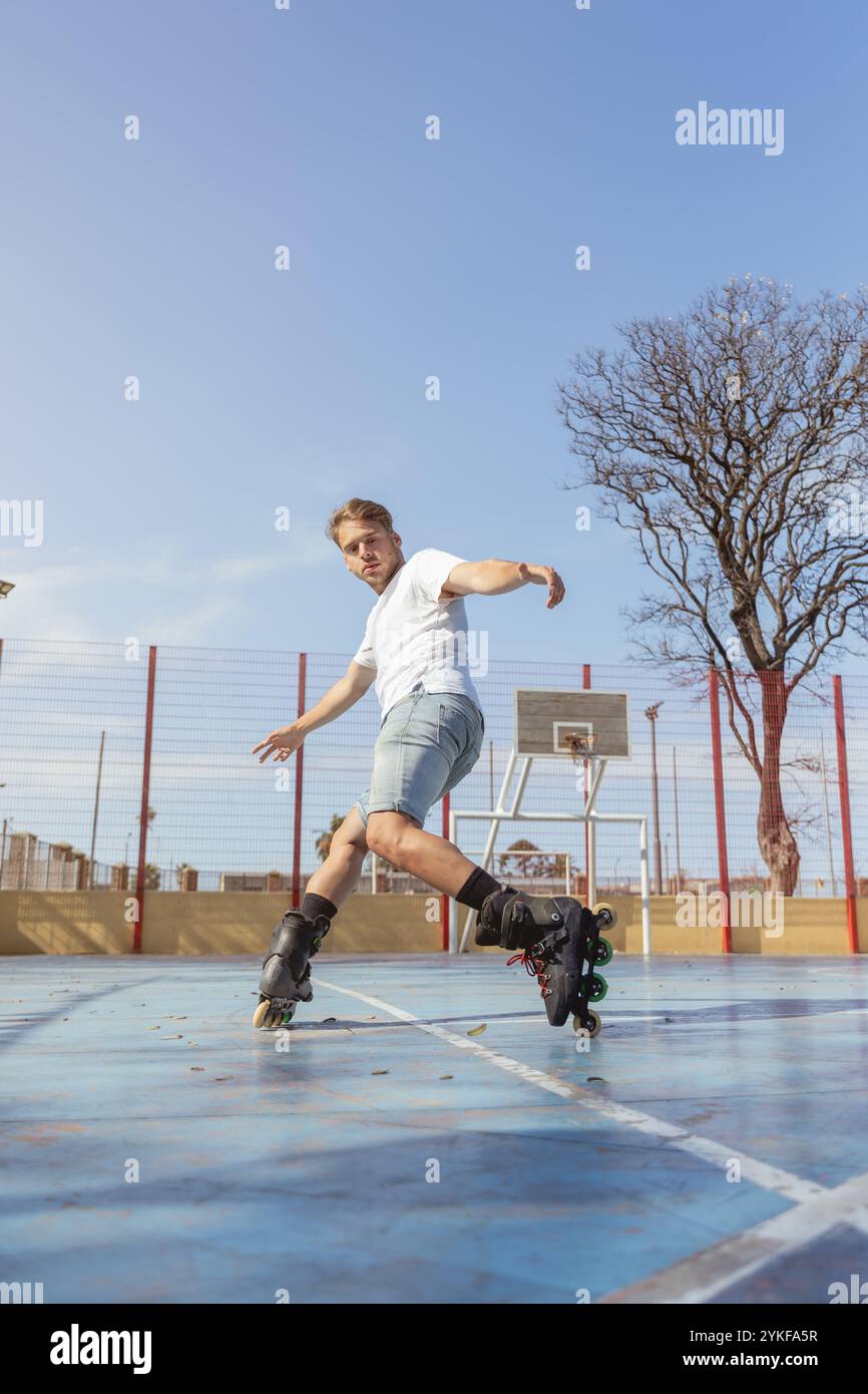 from below a young man is captured in action while rollerblading on ...