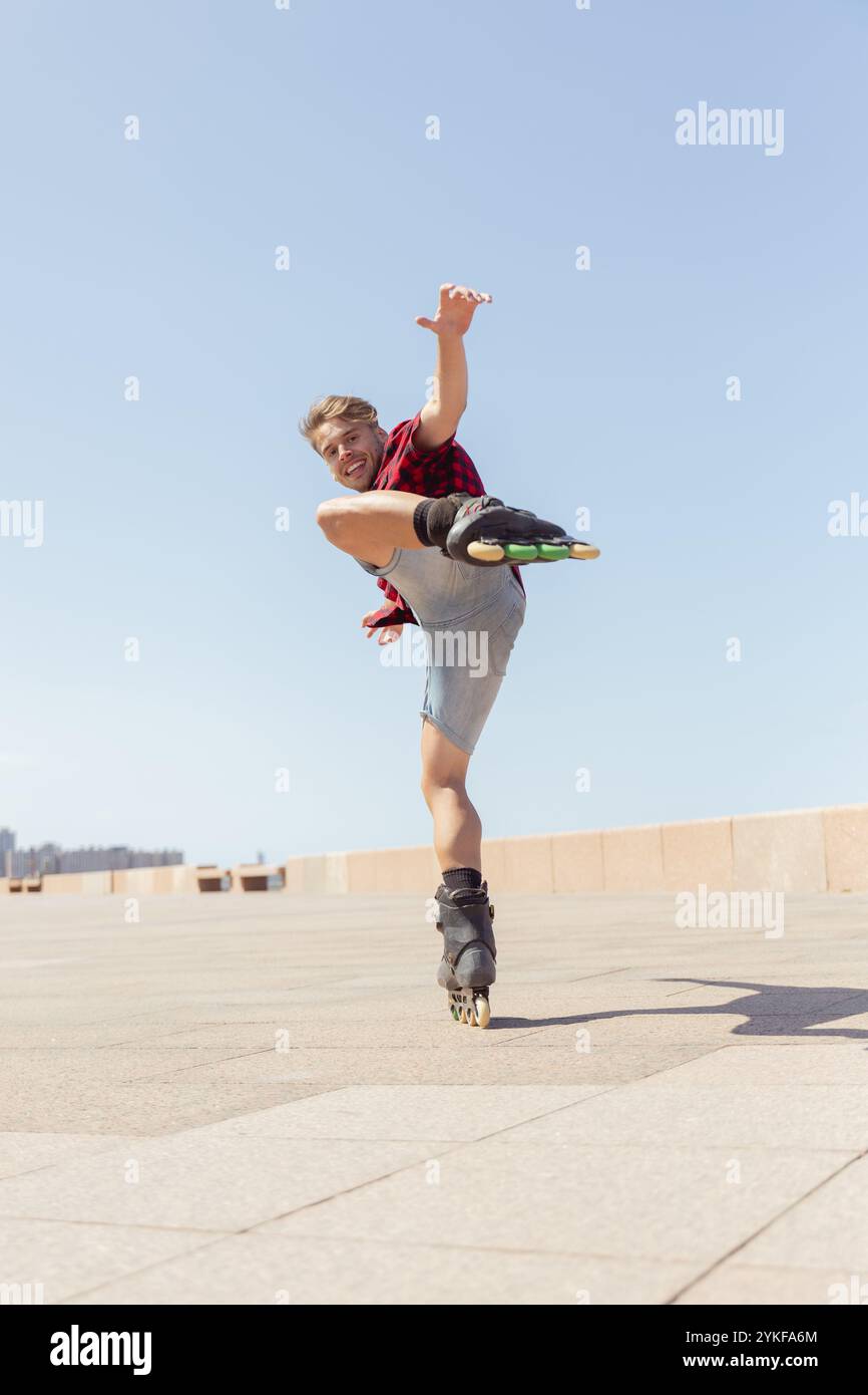 Energetic young man demonstrating a dynamic trick on inline skates at ...