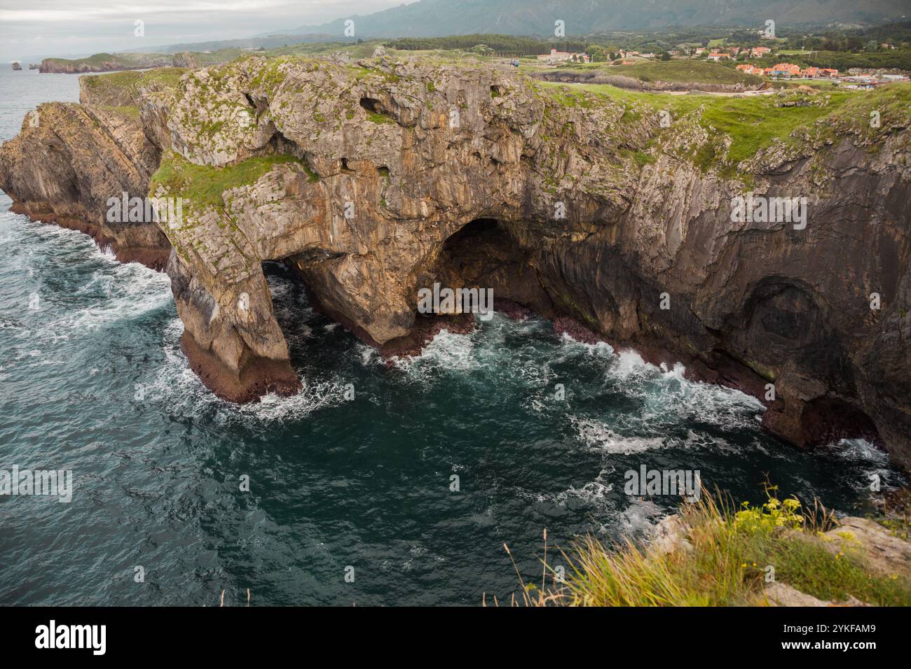 View of the steep cliffs and coastal arches of Asturias, Spain, with ...