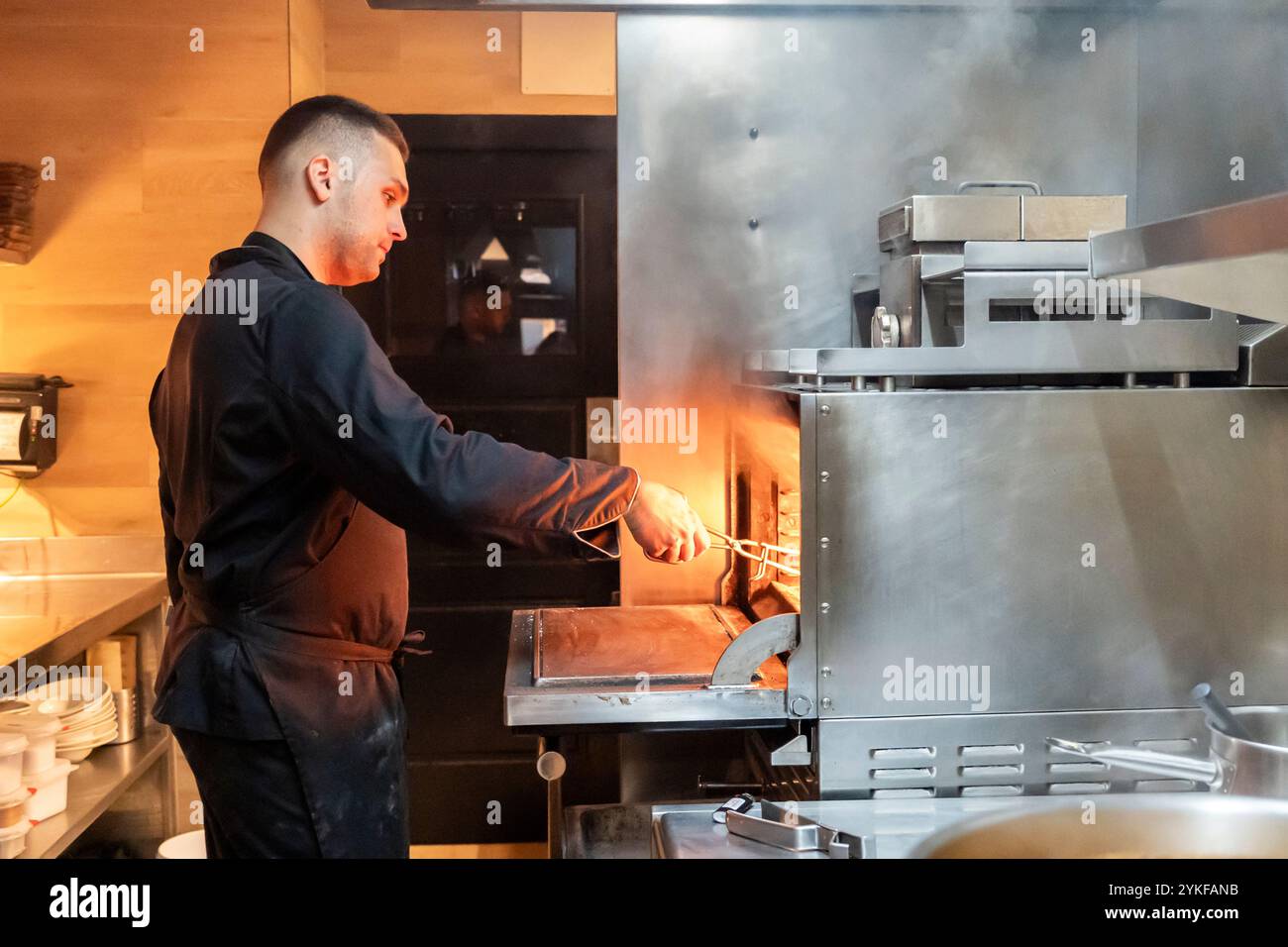 An expert chef serving meals in the bustling kitchen of a restaurant ...