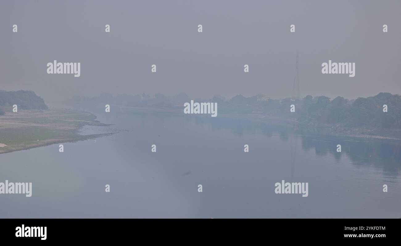 A misty scene of the River Yamuna as it flows past the Taj Mahal, Agra ...