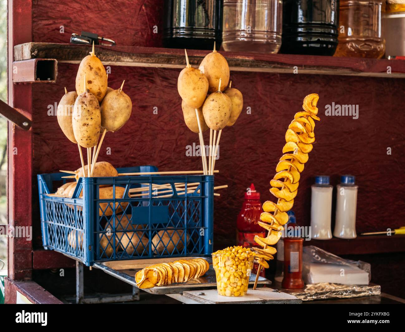 Fried spiral spring potato chips on stick with corn cup, Georgian ...