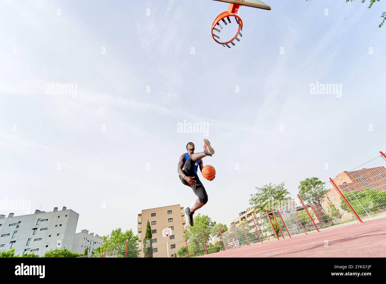 black basketball player dunking on an outdoor court Stock Photo - Alamy