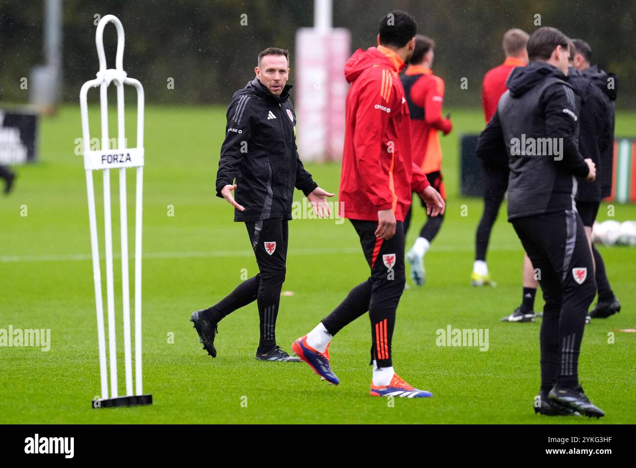 Wales manager Craig Bellamy (left) speaks with Ben Cabango during a ...