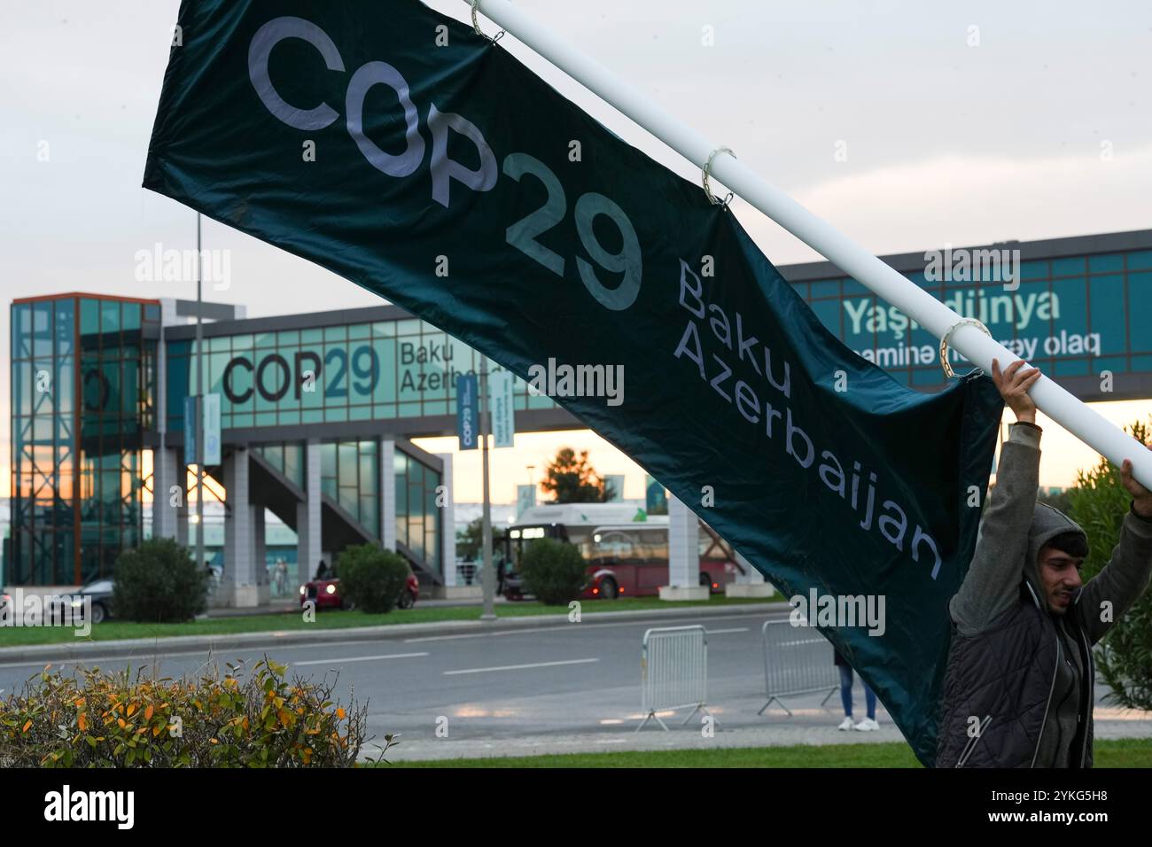 A flag is adjusted outside the venue for the COP29 U.N. Climate Summit ...