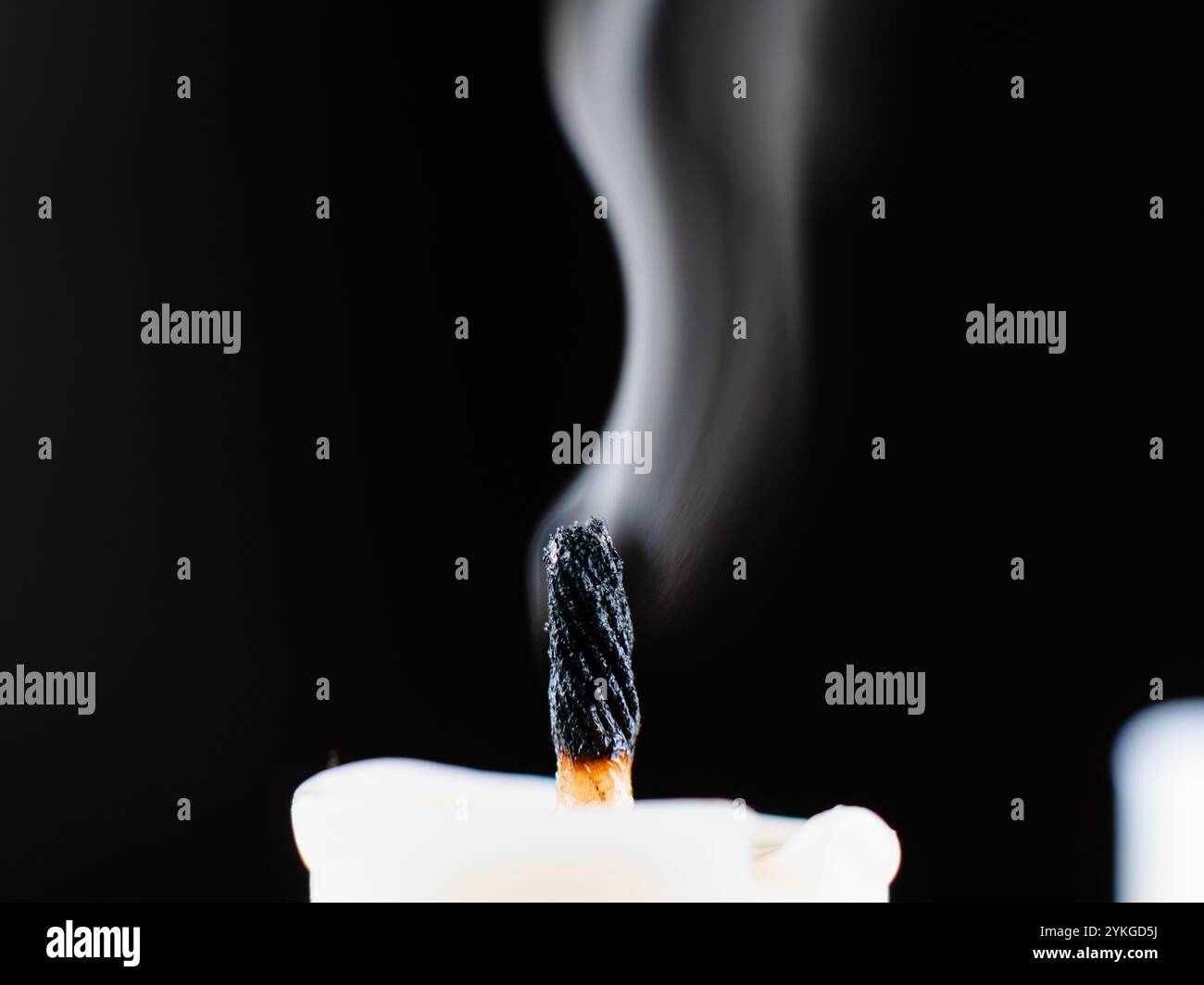 Candle wick smoking after being extinguished in darkness Stock Photo ...