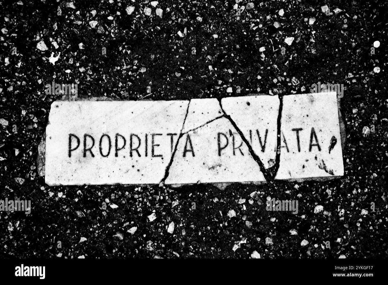 stone plaque set on the asphalt pavement with the inscription Private ...