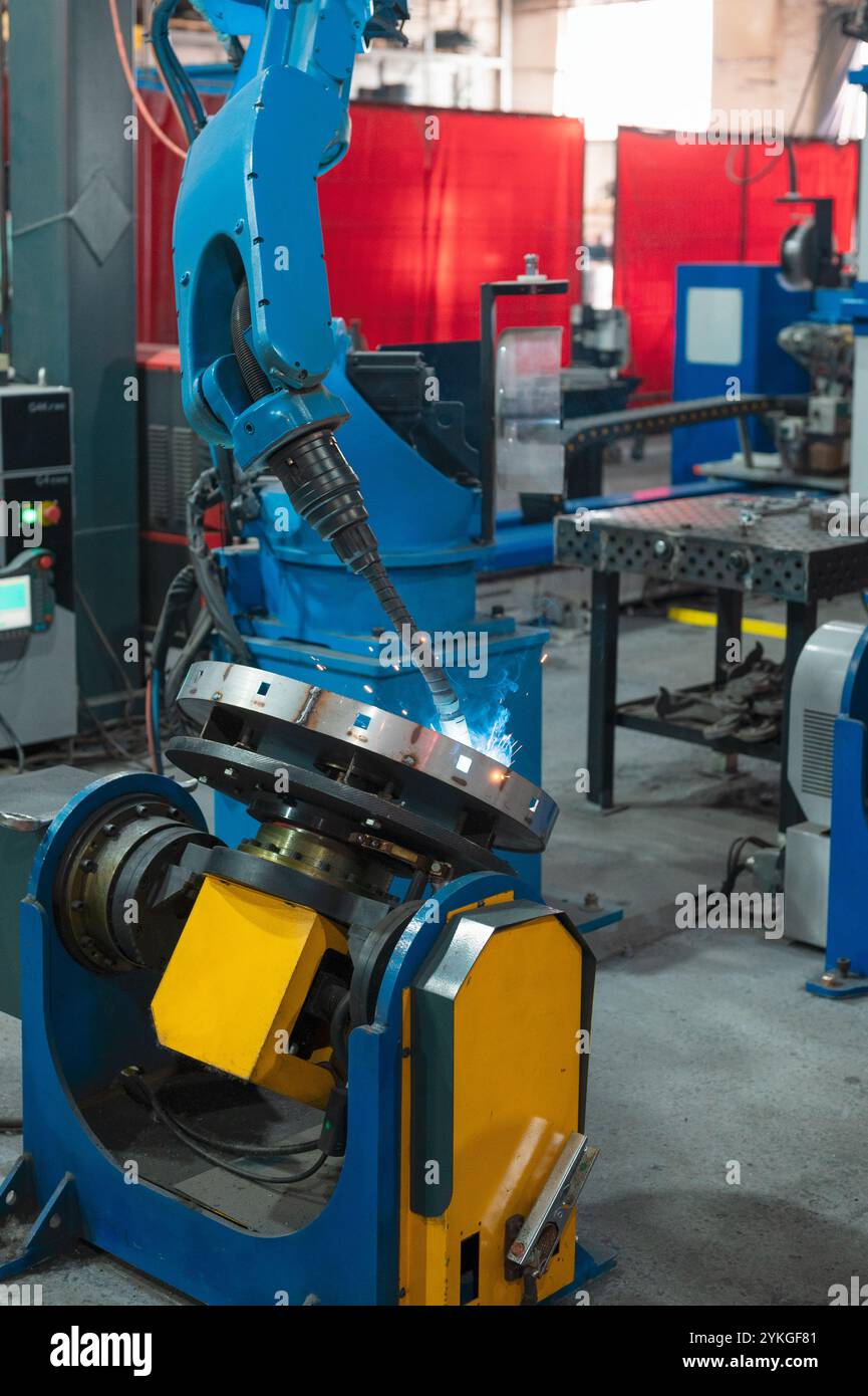 Automatic Industrial welding robot in a modern factory in operation ...