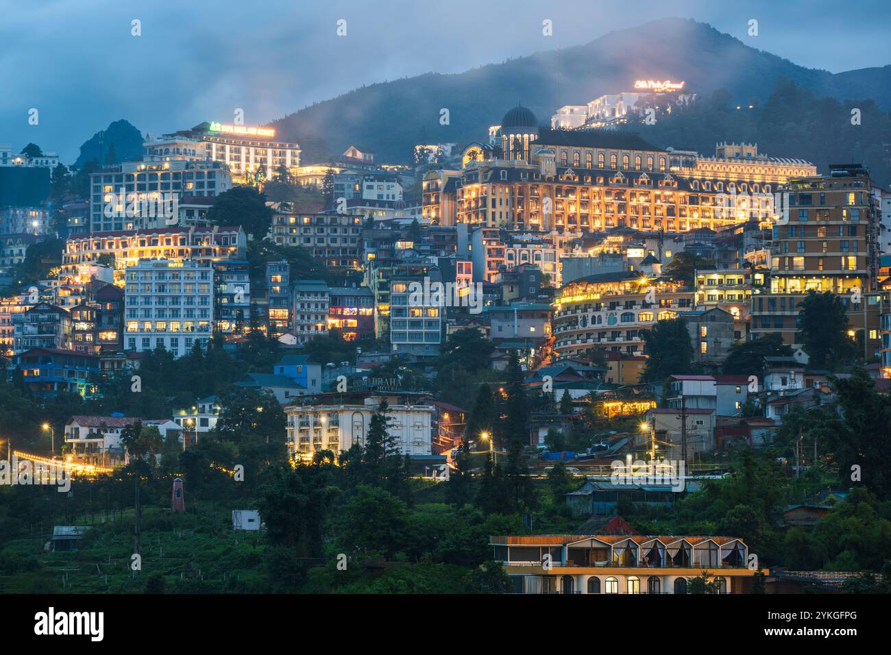 This is a night view of houses and buildings in the hills of Sapa, a ...