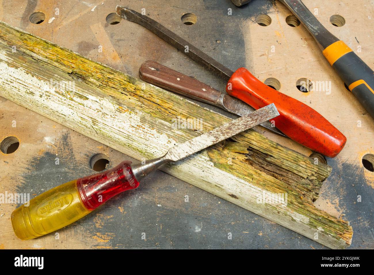 Woodworker's tools and a rotten section of wooden window surround on ...