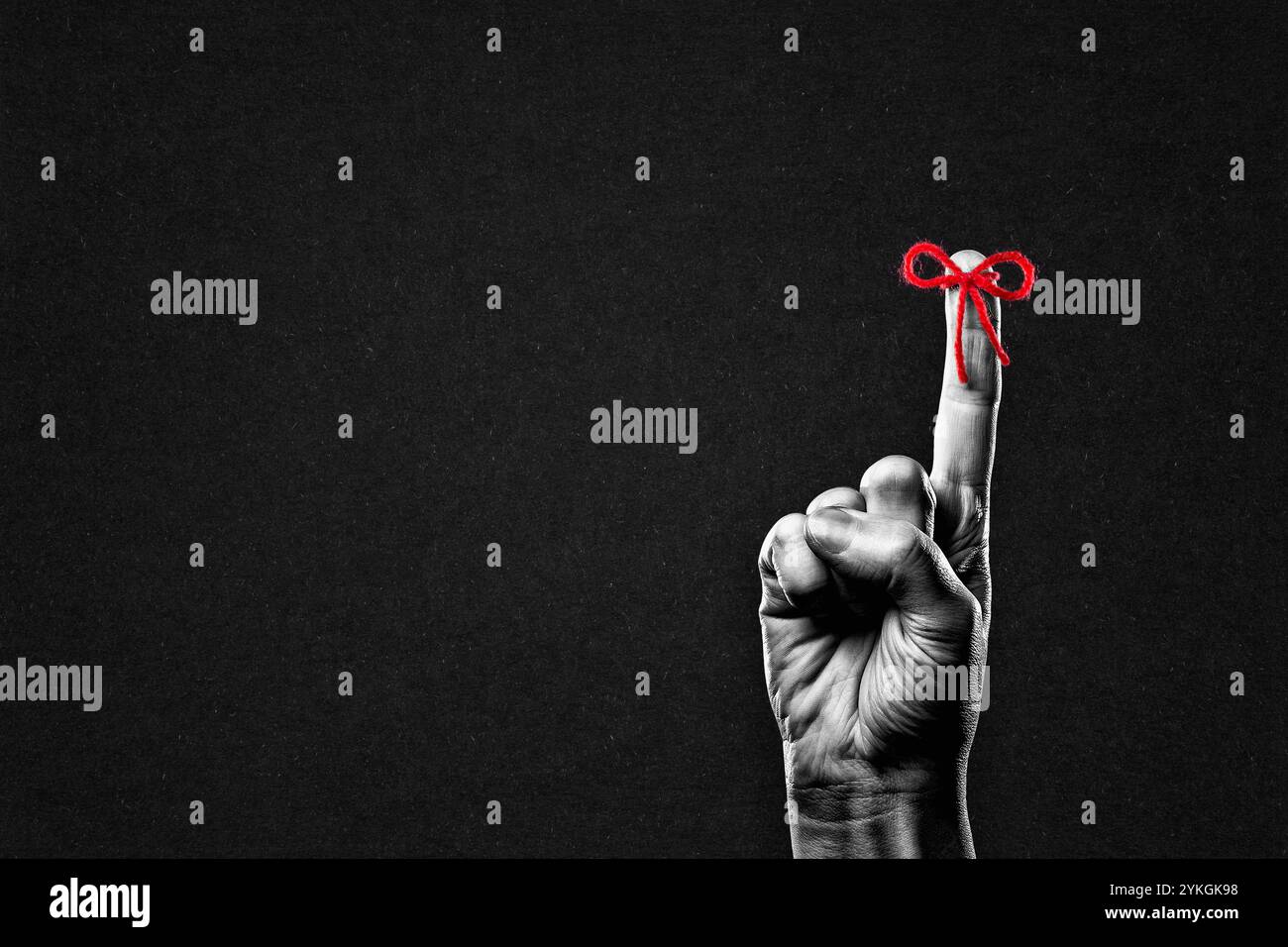 Rope Bow on Finger Pointing Sign in Black and White on Textured Paper ...