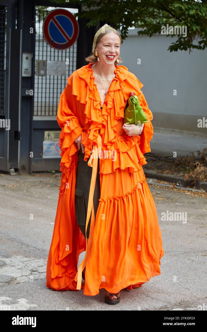 MILAN, ITALY - SEPTEMBER 21, 2024: Chloe King with orange dress before ...